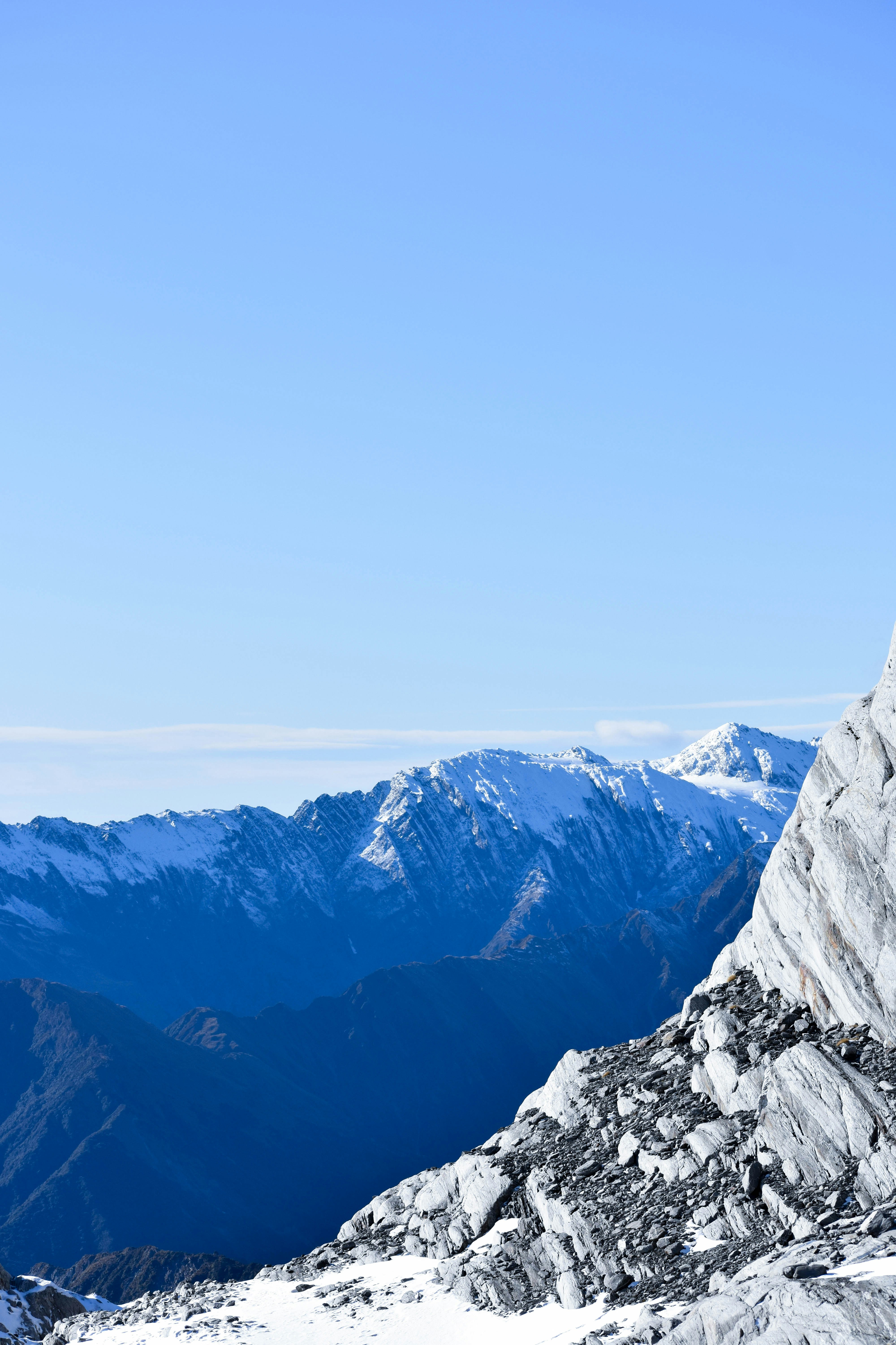 Edge of the Icefall: Snow-Rimmed Ridge Beneath an Azure Span