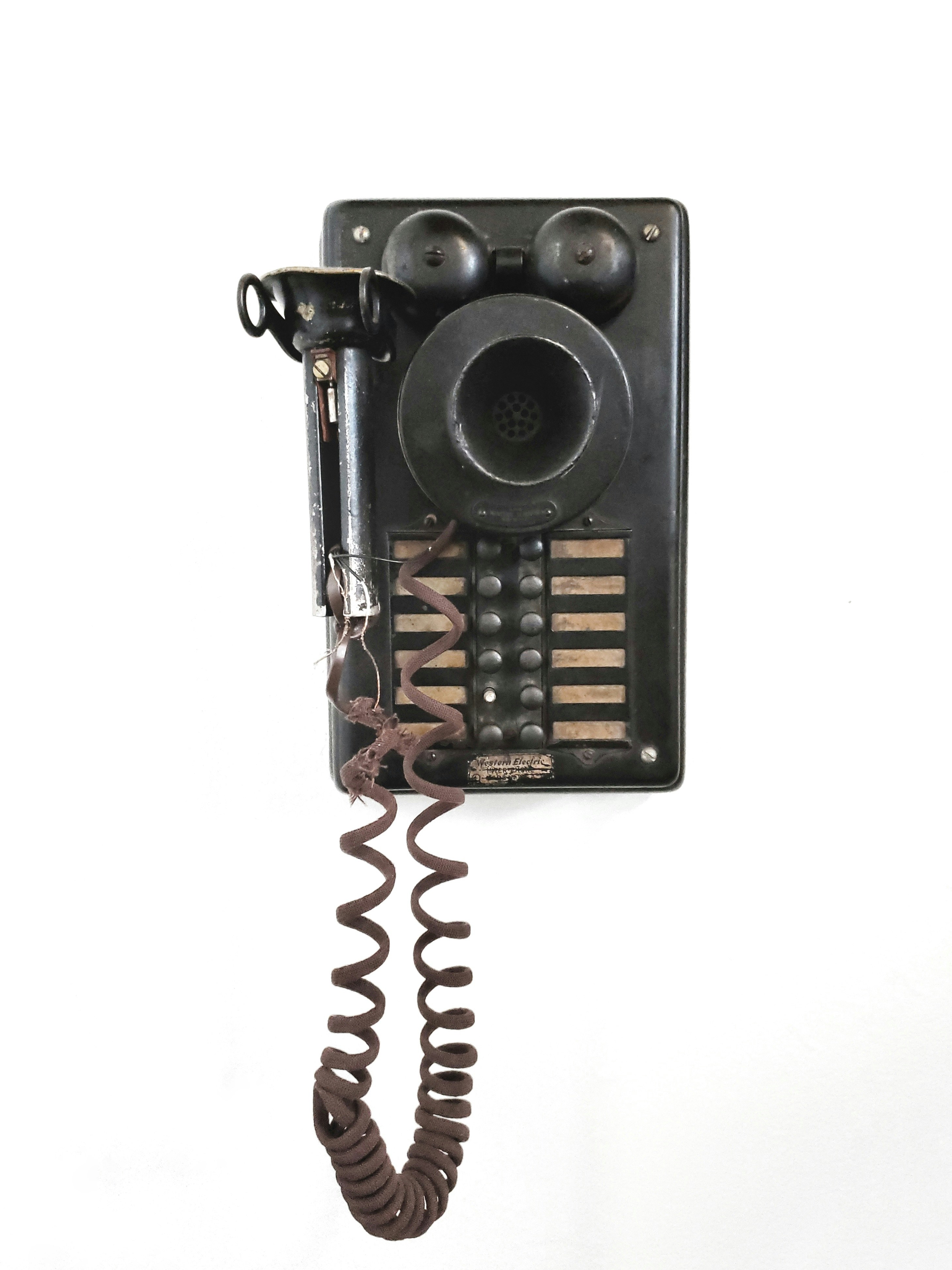 Coiled Echo on a White Wall: A Vintage Telephone Portrait