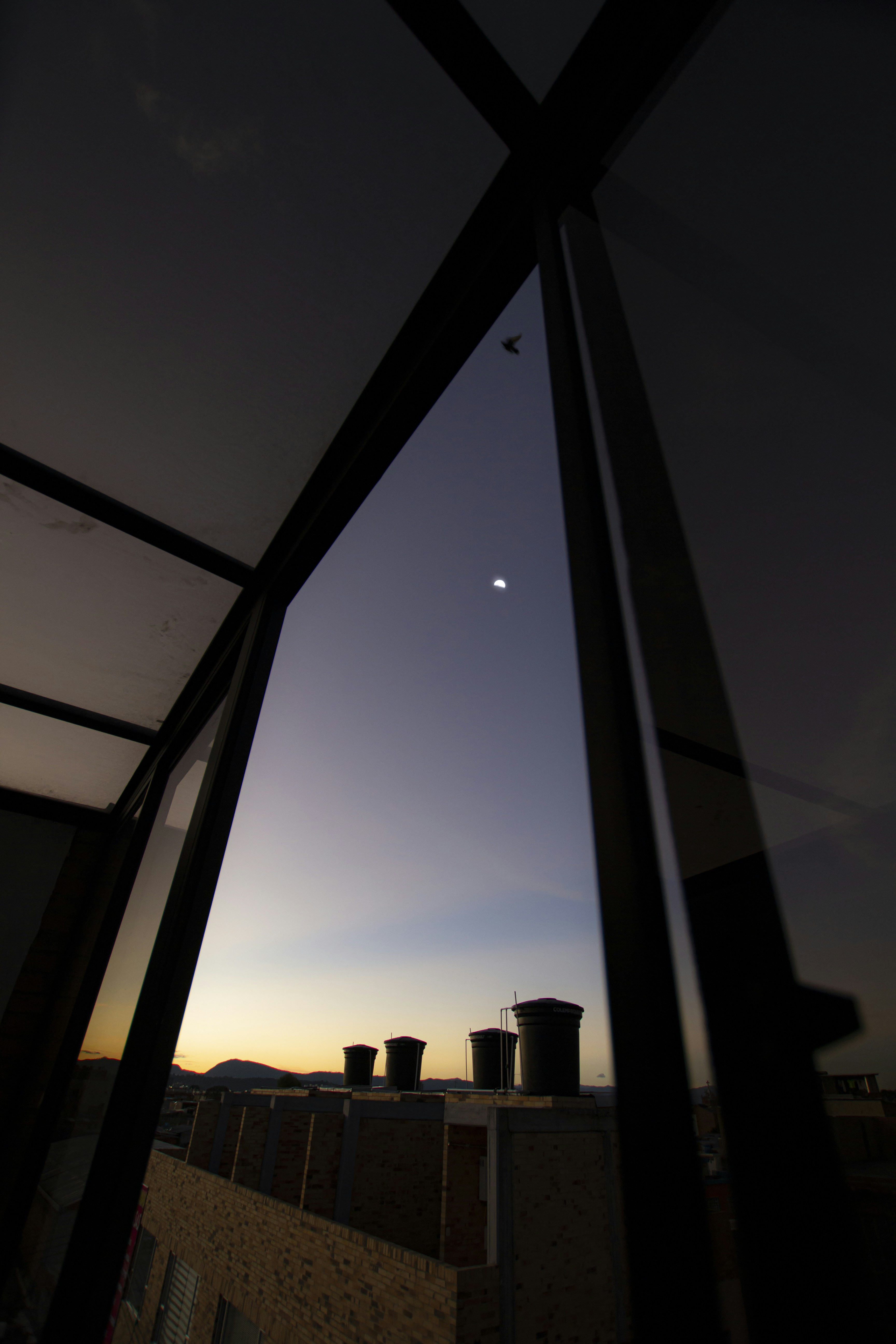 Moonlit Skyline Through Slatted Glass
