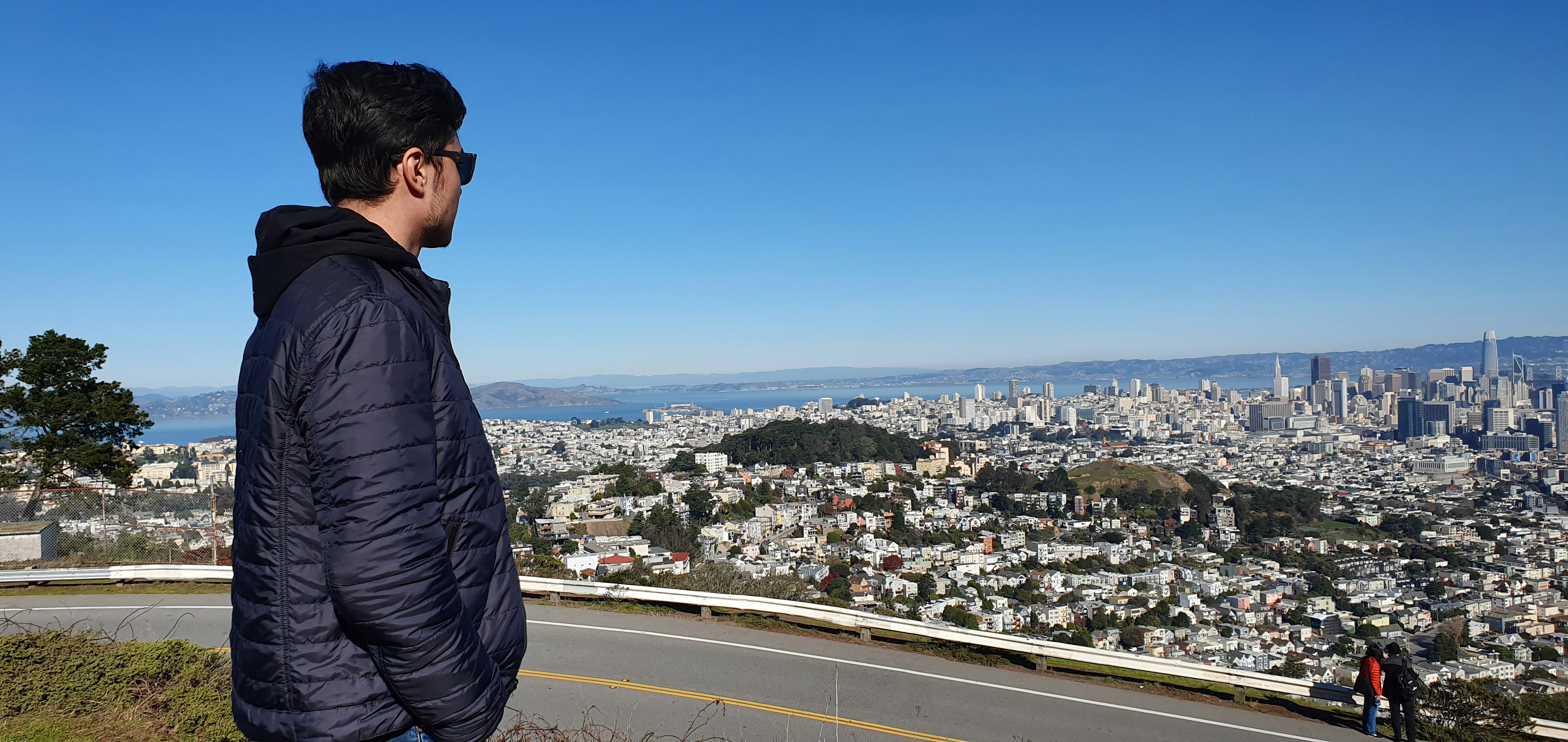 Ridgeview Gazer: A solitary silhouette surveys a sunlit metropolis