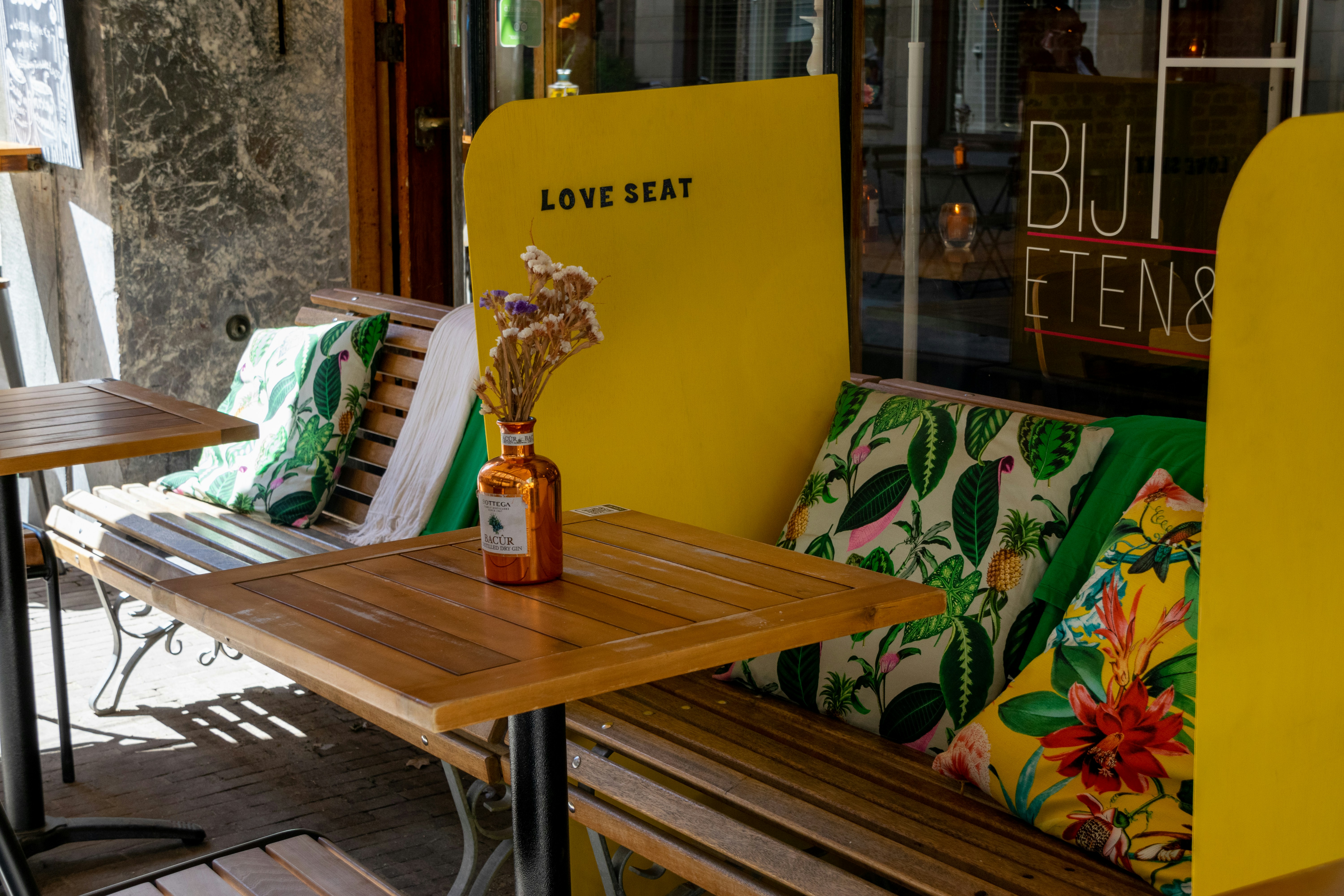 brown wooden table with yellow and white signage