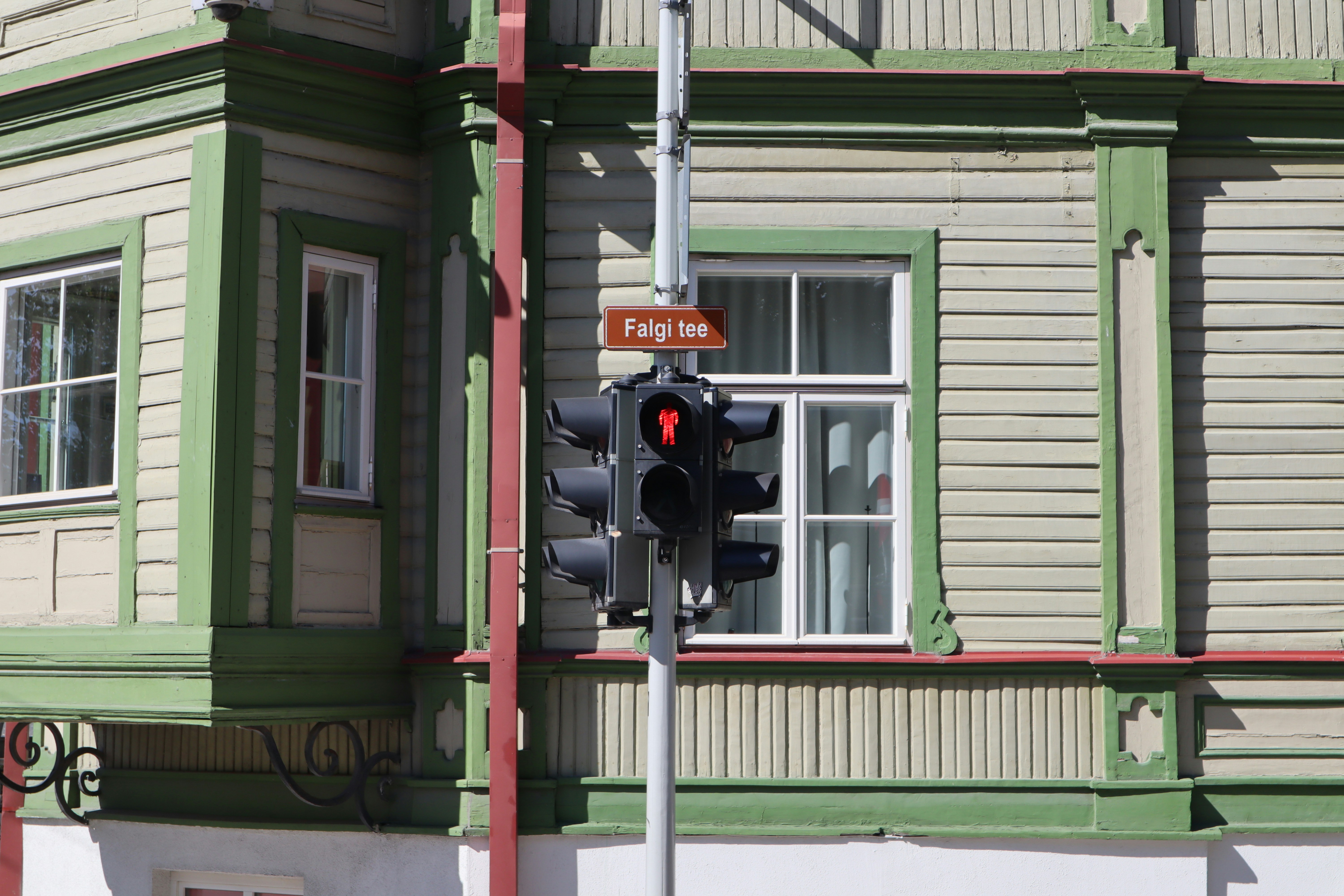 black traffic light on red stop sign
