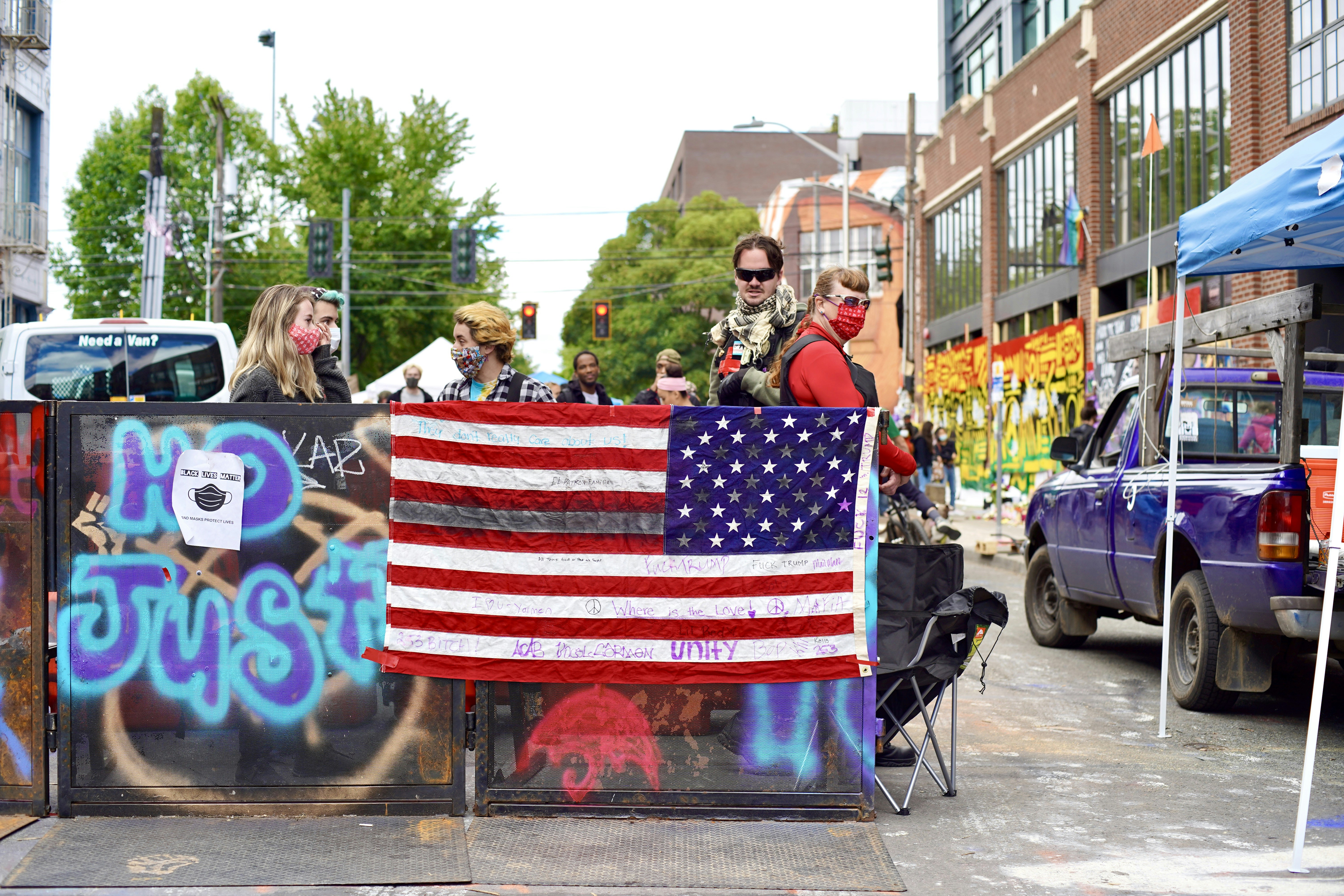 A Tapestry of Voices: A City Block Rally Beneath an American Flag