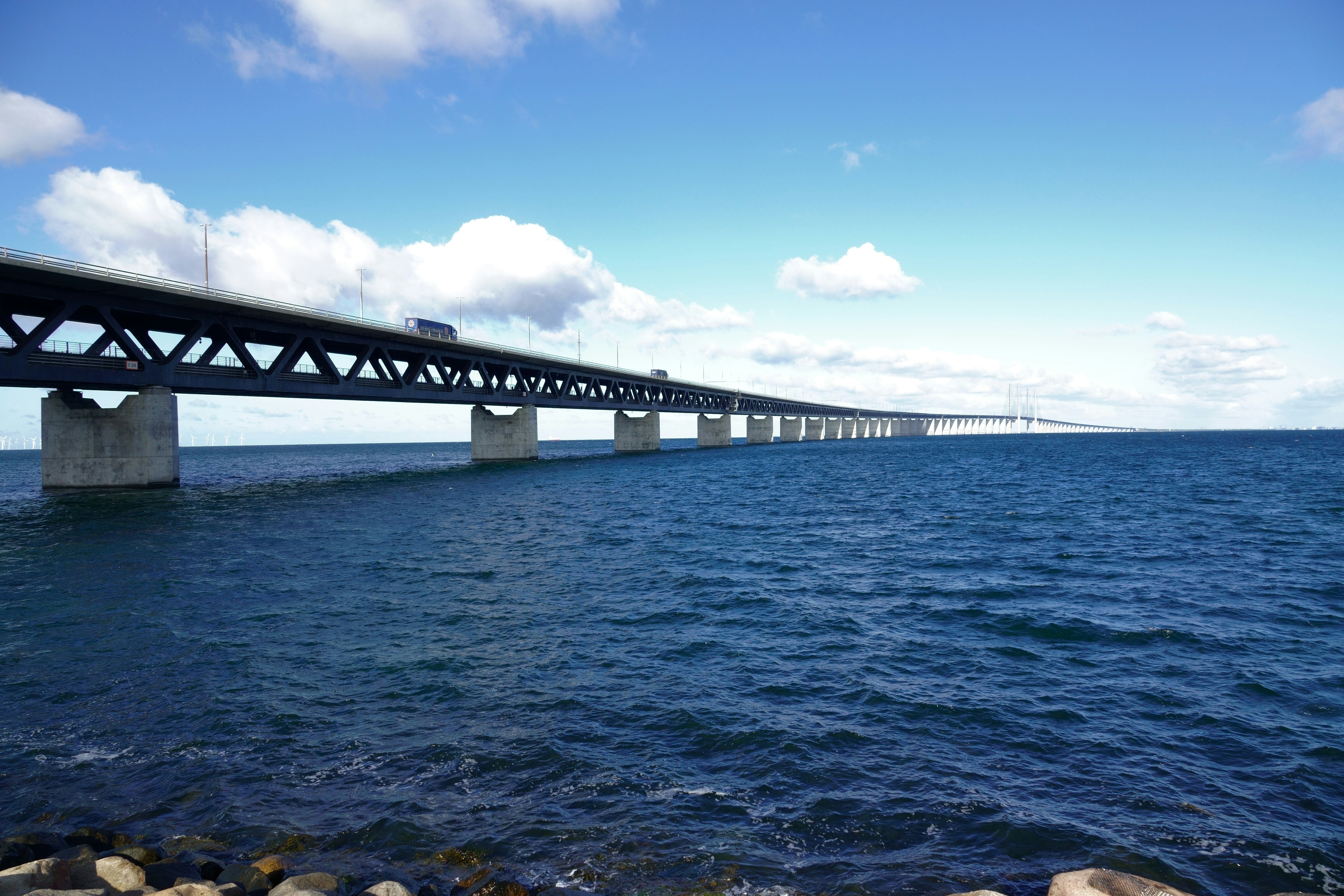 Gray bridge over the sea under blue sky during daytime photo – Free ...