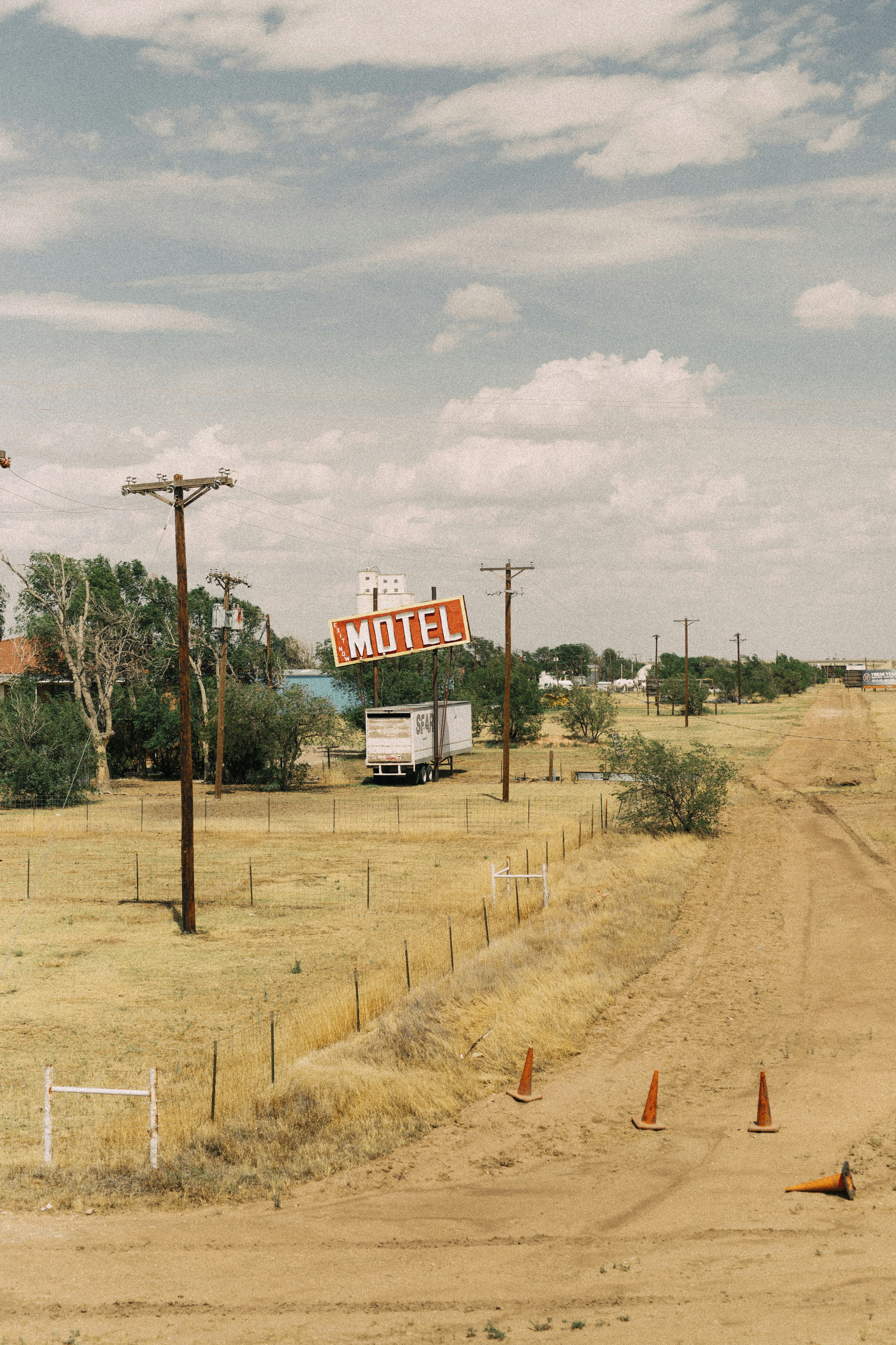 Dusty Desert Road Motel Sign: A Lone Beacon on the Horizon