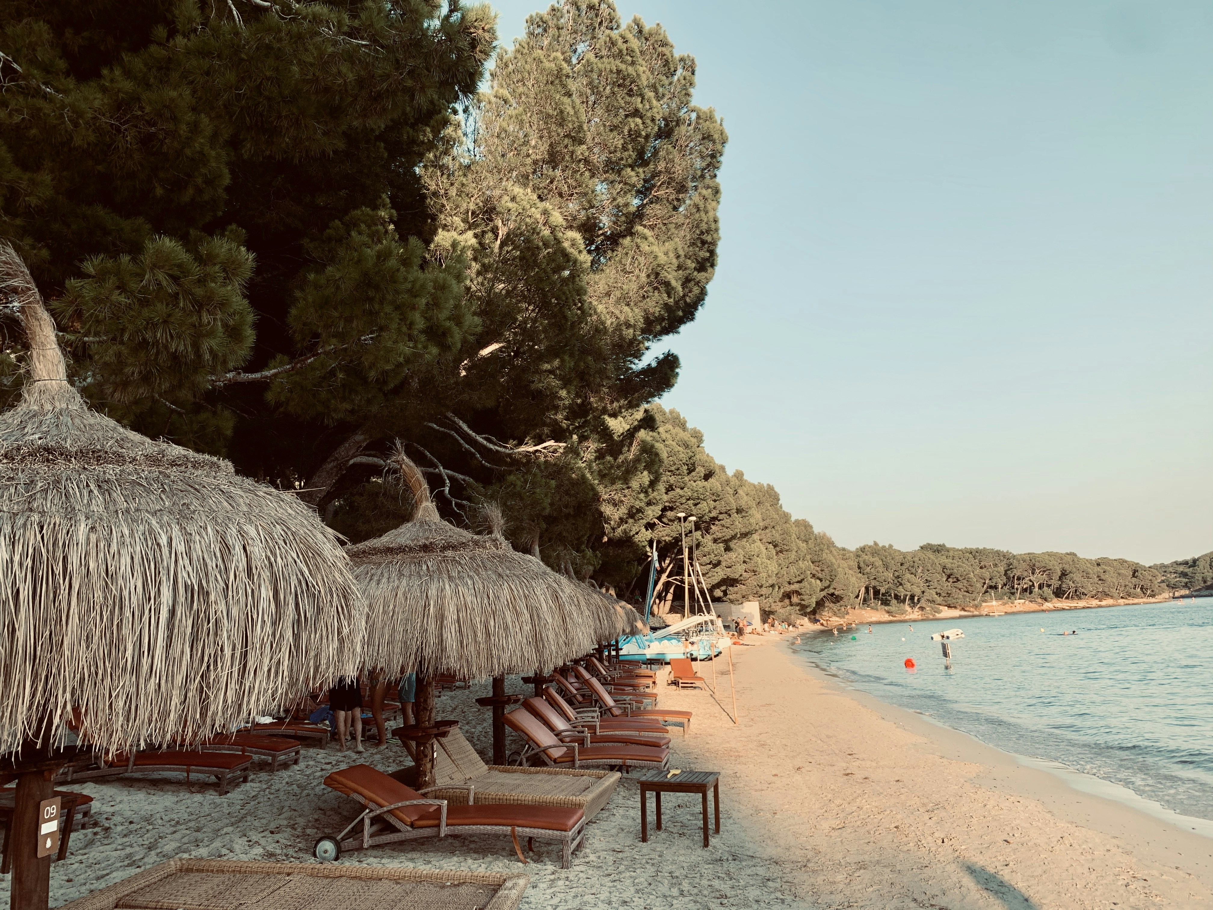 brown wooden house near body of water during daytime