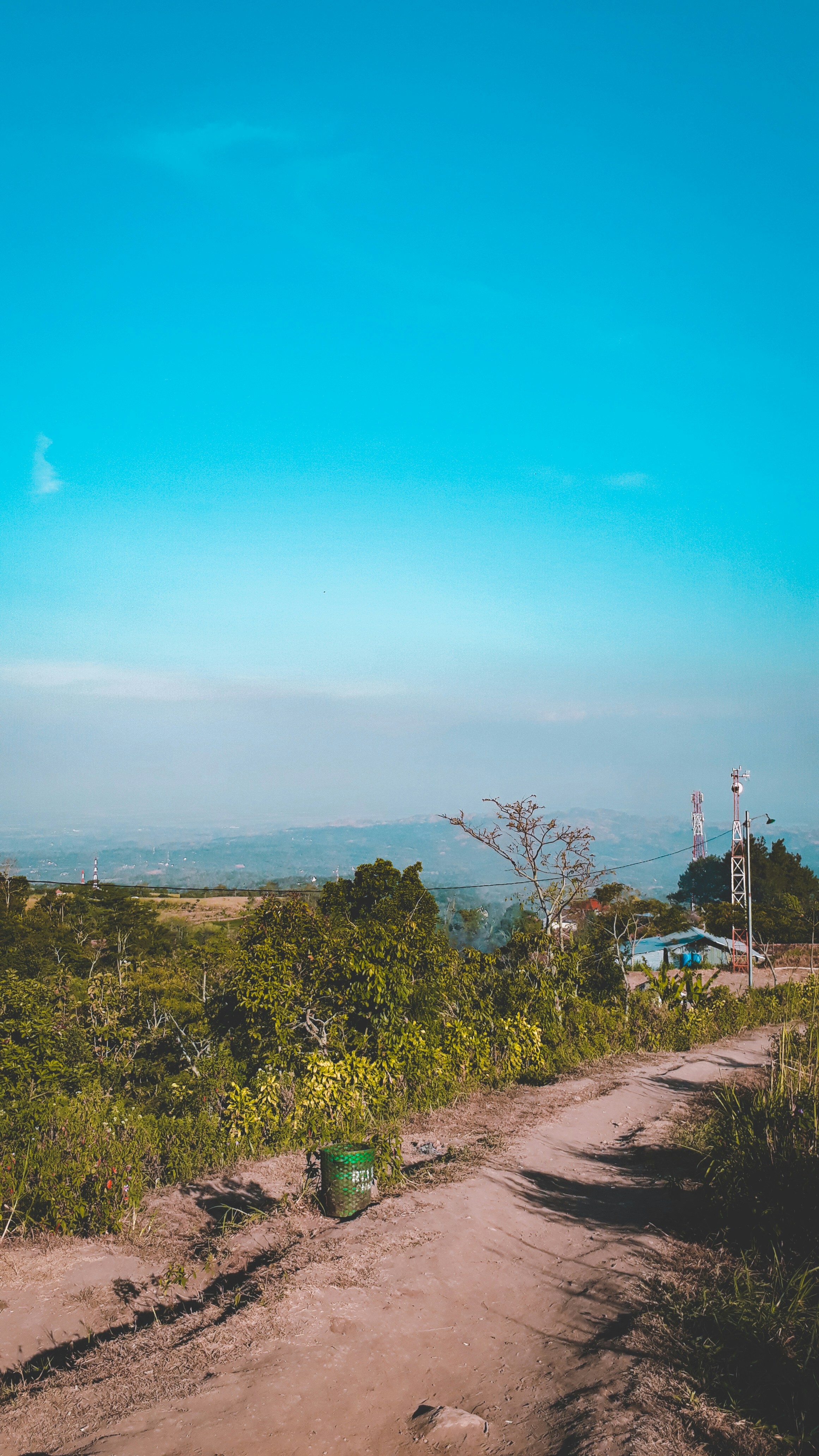 Dust Trail to the Distant Ridge under a Cerulean Sky