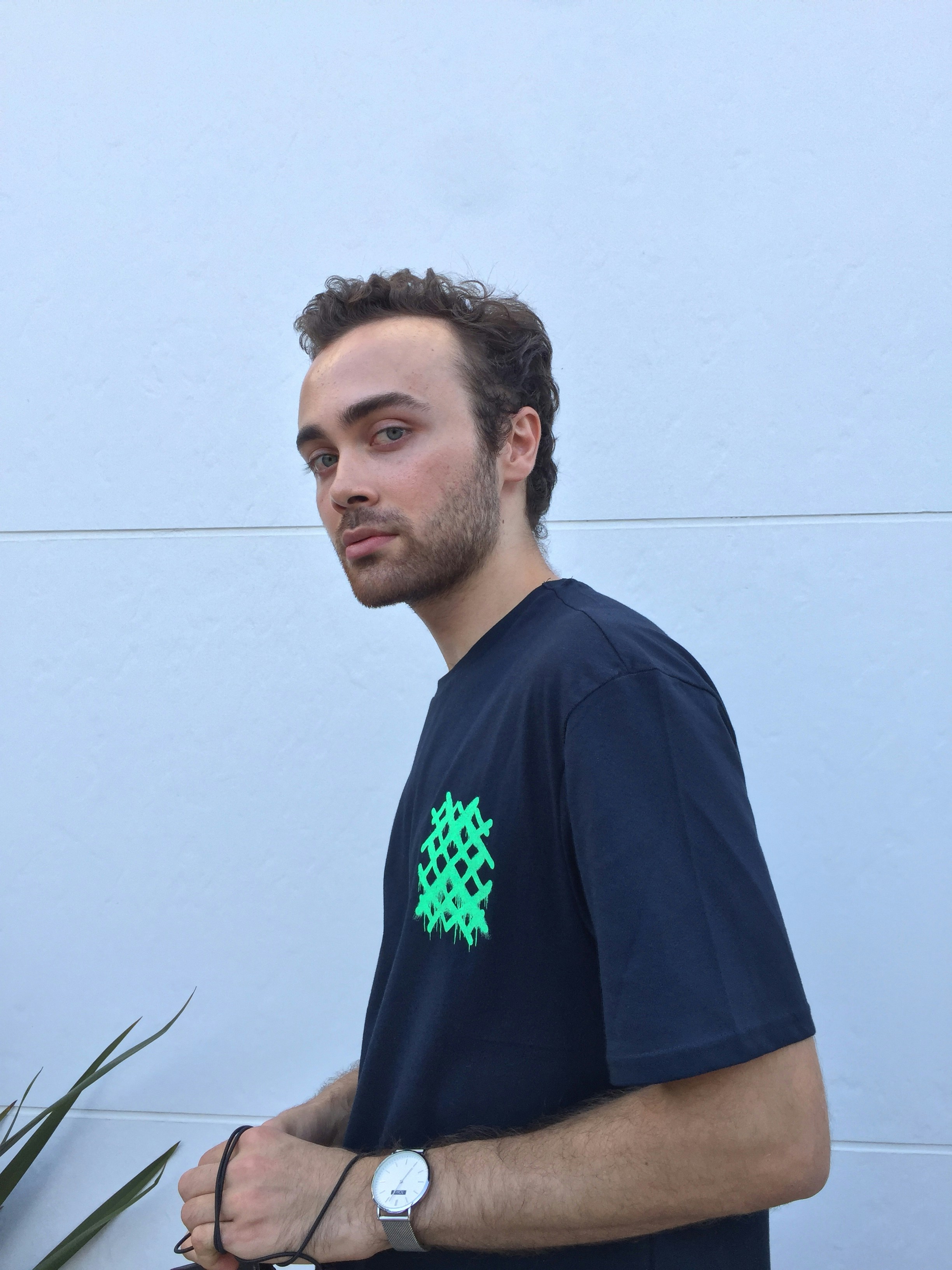 Gaze in Blue: Portrait of a Man in a Neon-Lattice Tee