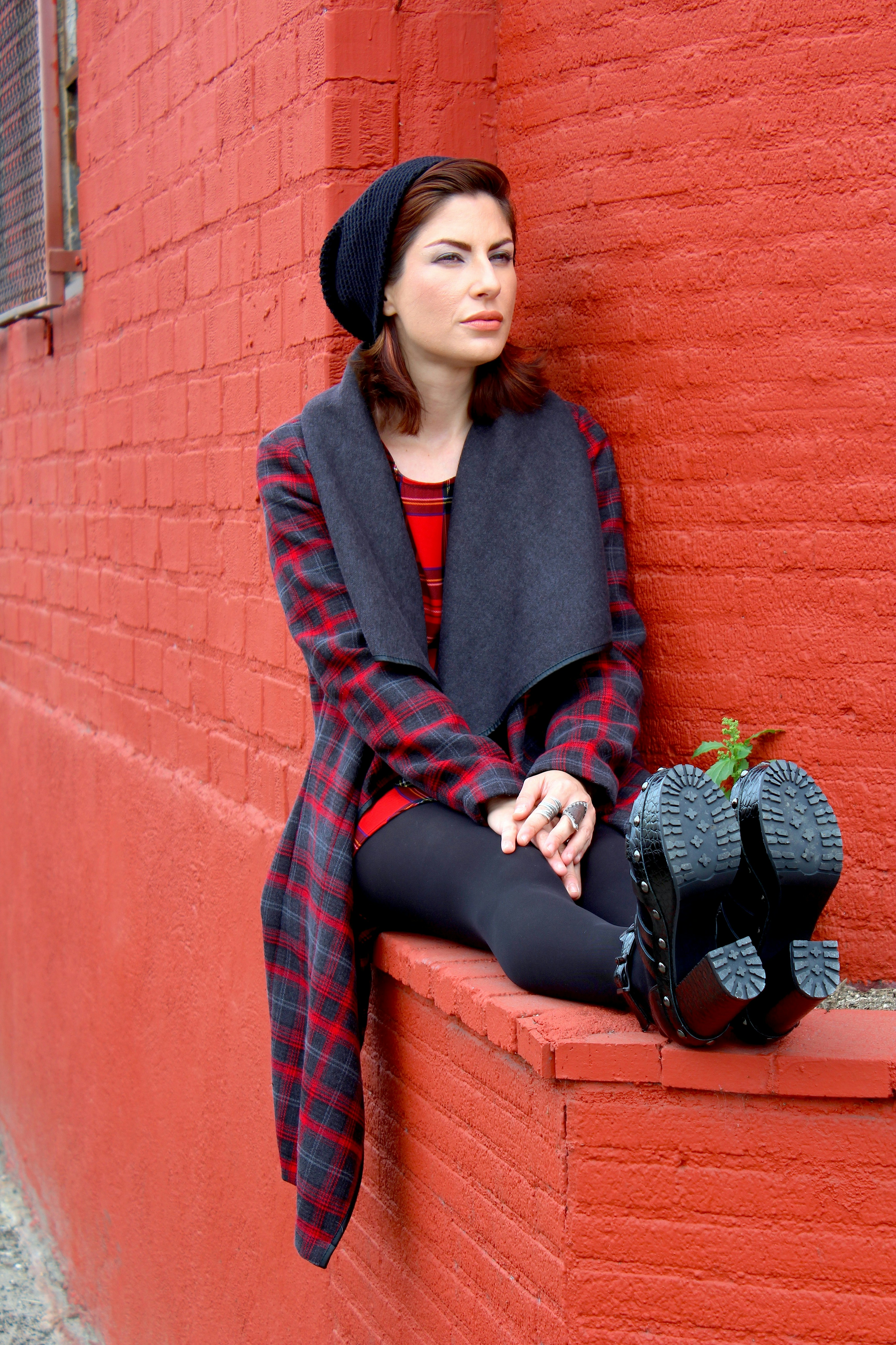 Red Wall Reverie: A Quiet Moment on a Brick Terrace