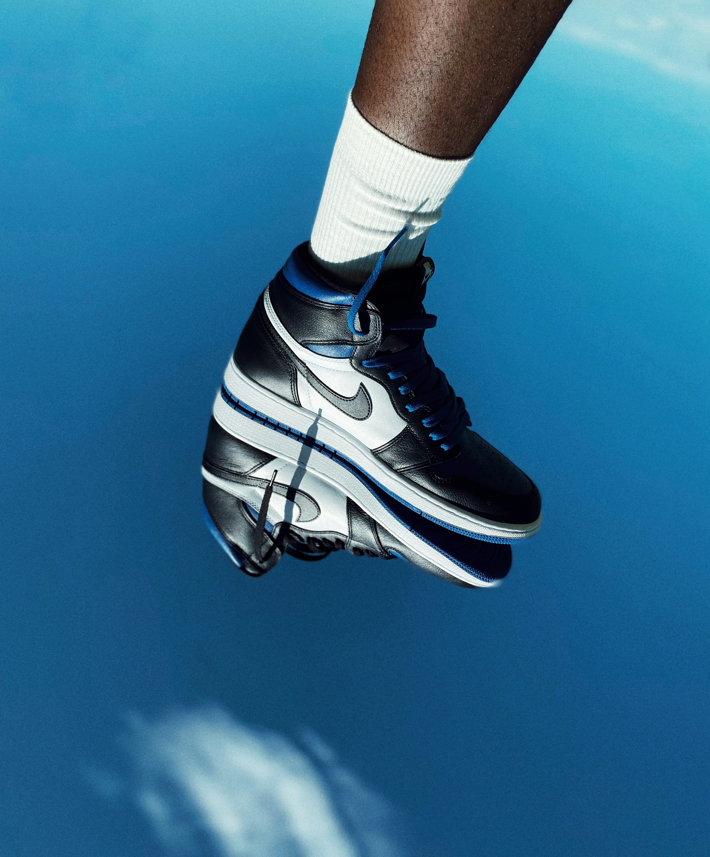 Skybound Kicks: A Nike Sneaker Hovering Over a Cobalt Sky