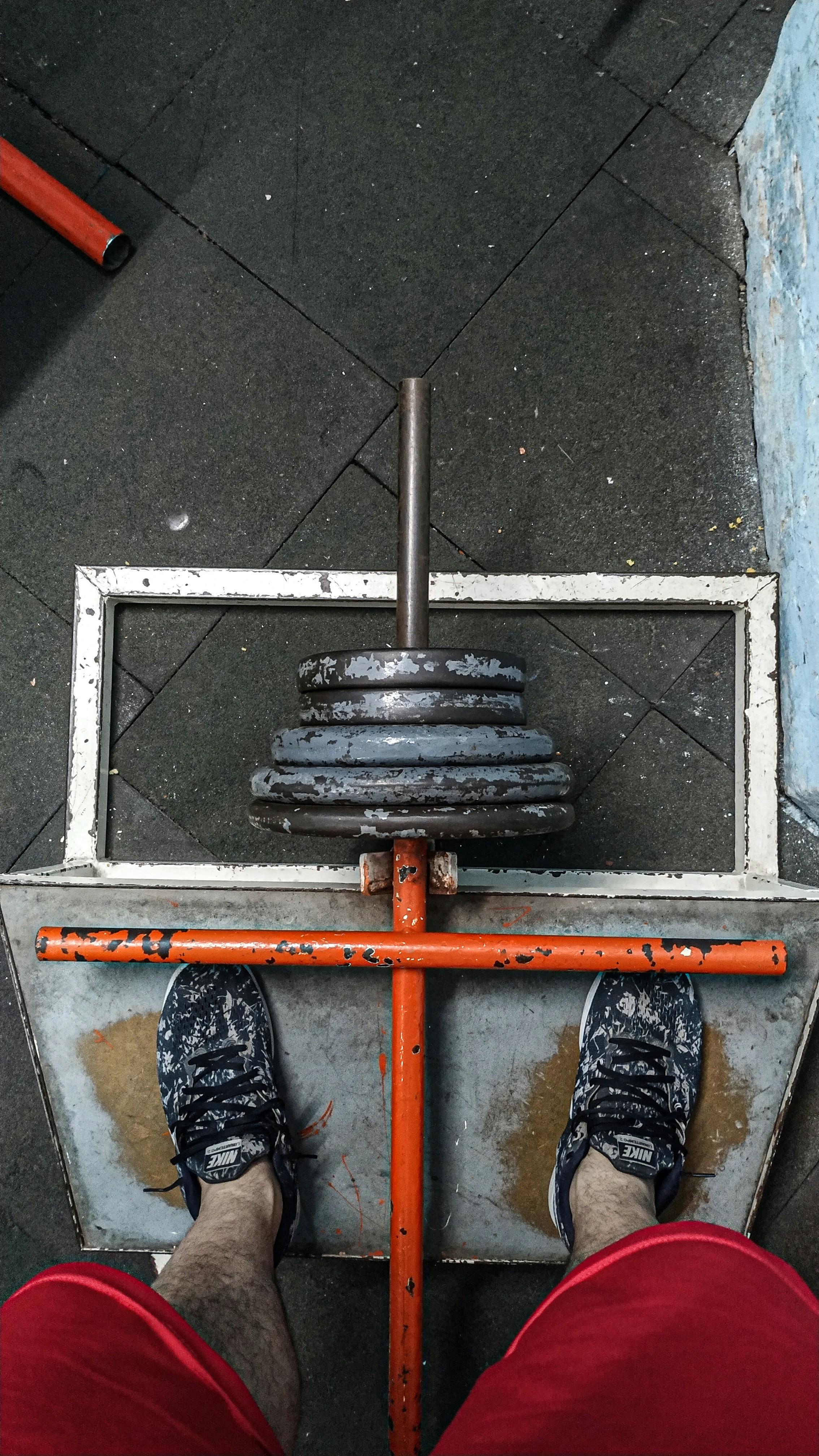 Weight plates stacked on a barbell with a view from above, showcasing a workout setup. The scene captures the essence of dedication and fitness.
