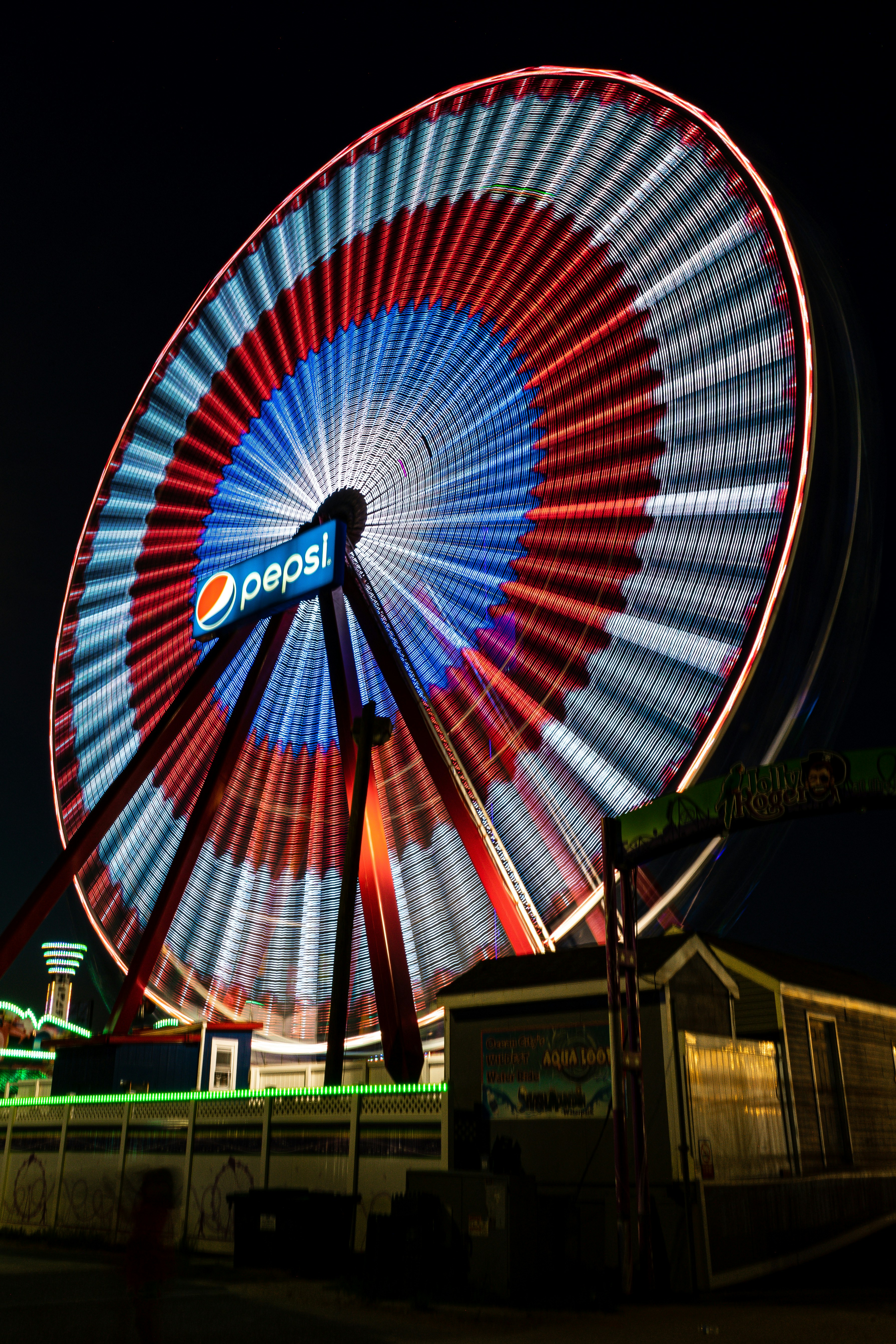 Neon Spiral over Pepsi Ferris Wheel in Night Motion