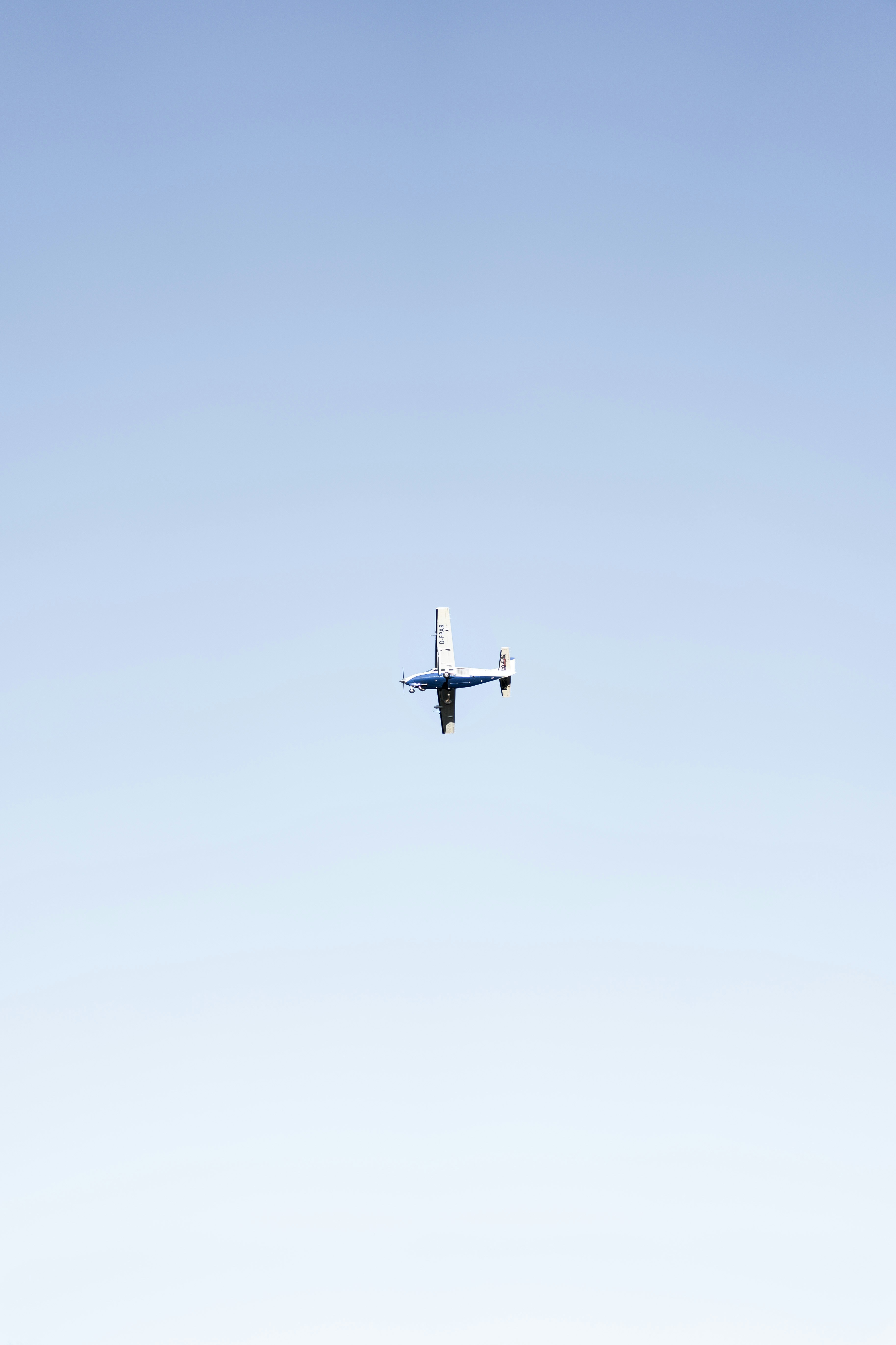 white airplane flying in the sky during daytime