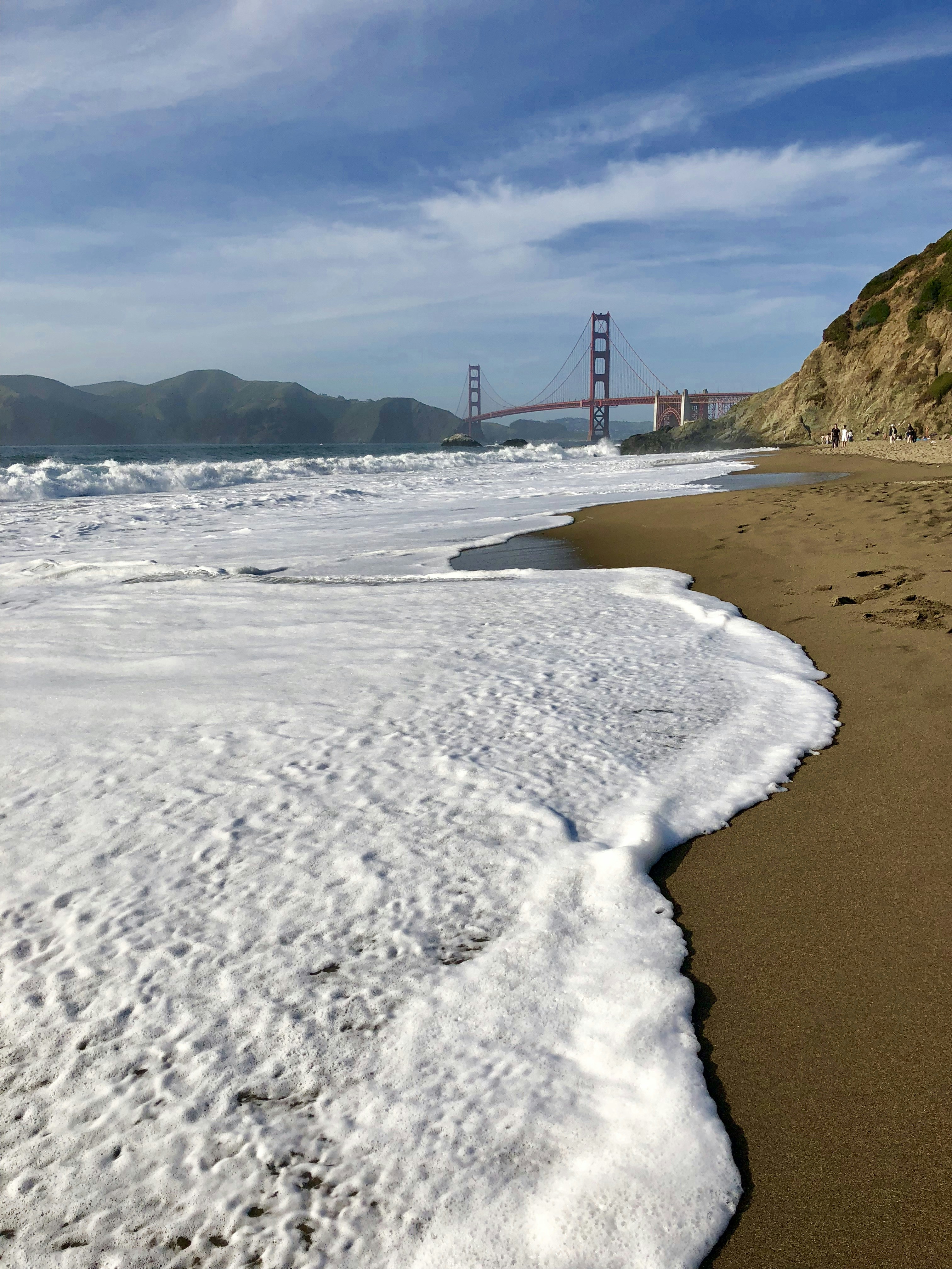 Foamy Edge to the Golden Span: Coastal Light near the Bay