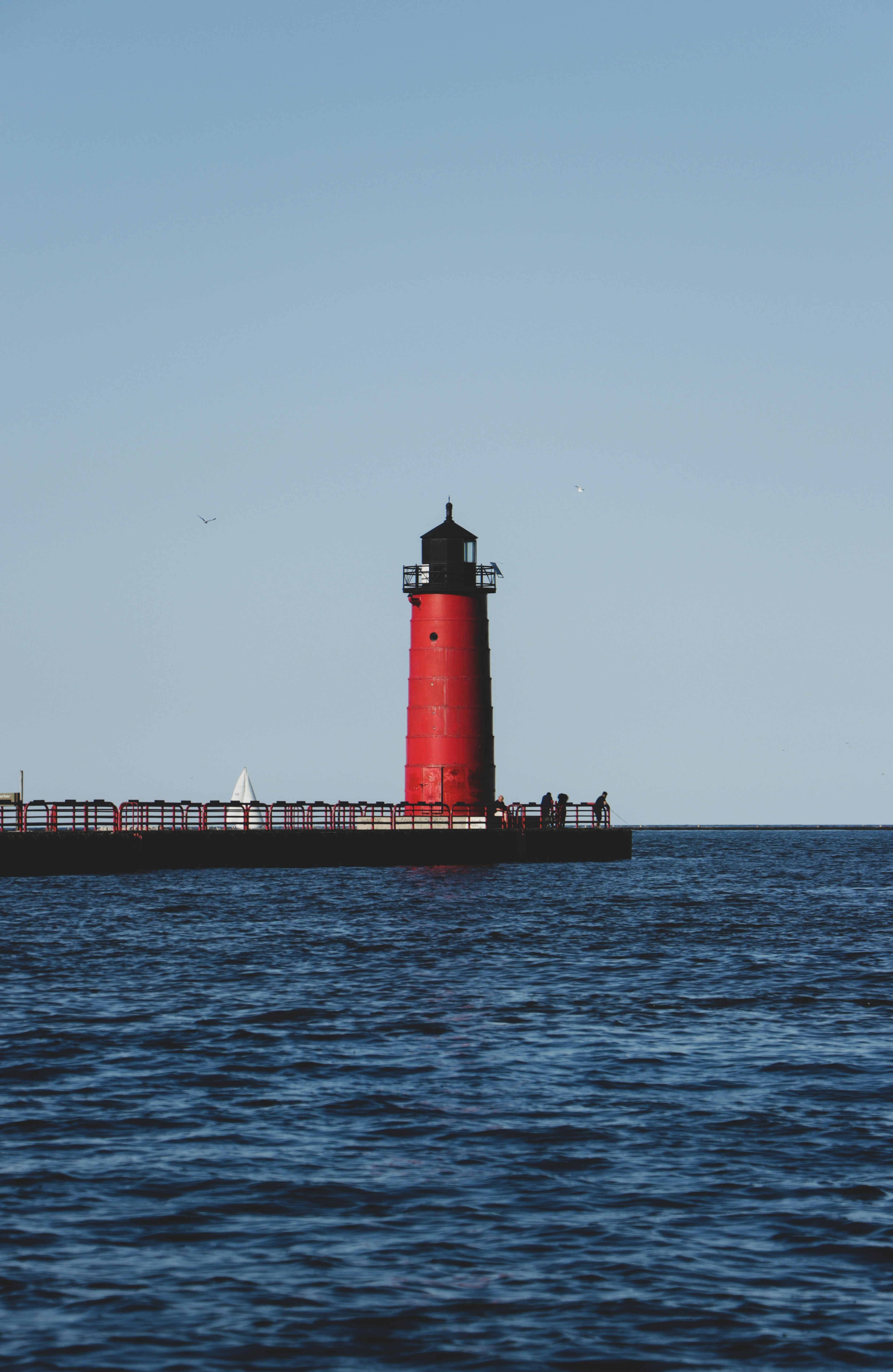 Red and white lighthouse on sea during daytime photo – Free Milwaukee ...