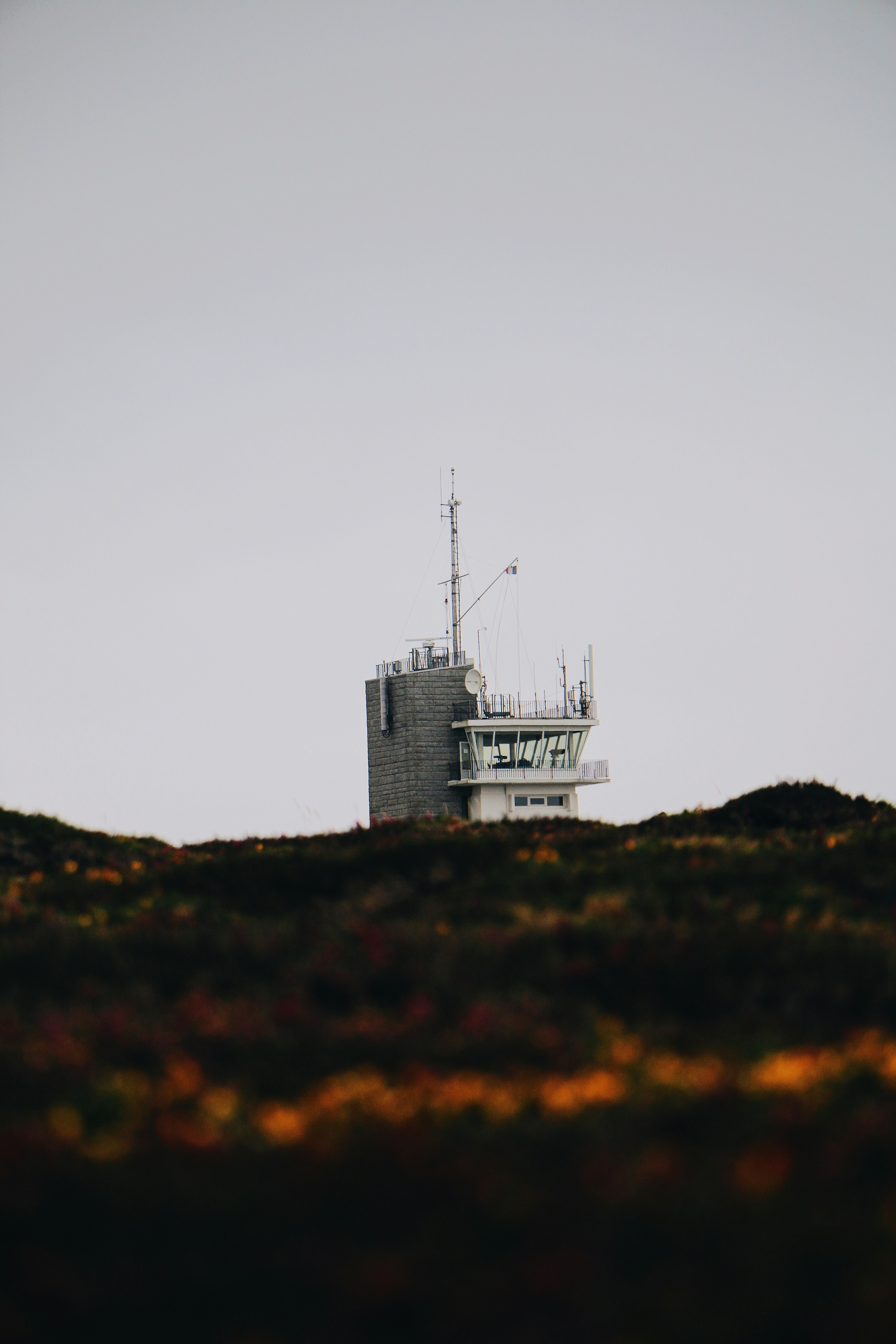white concrete building on top of hill