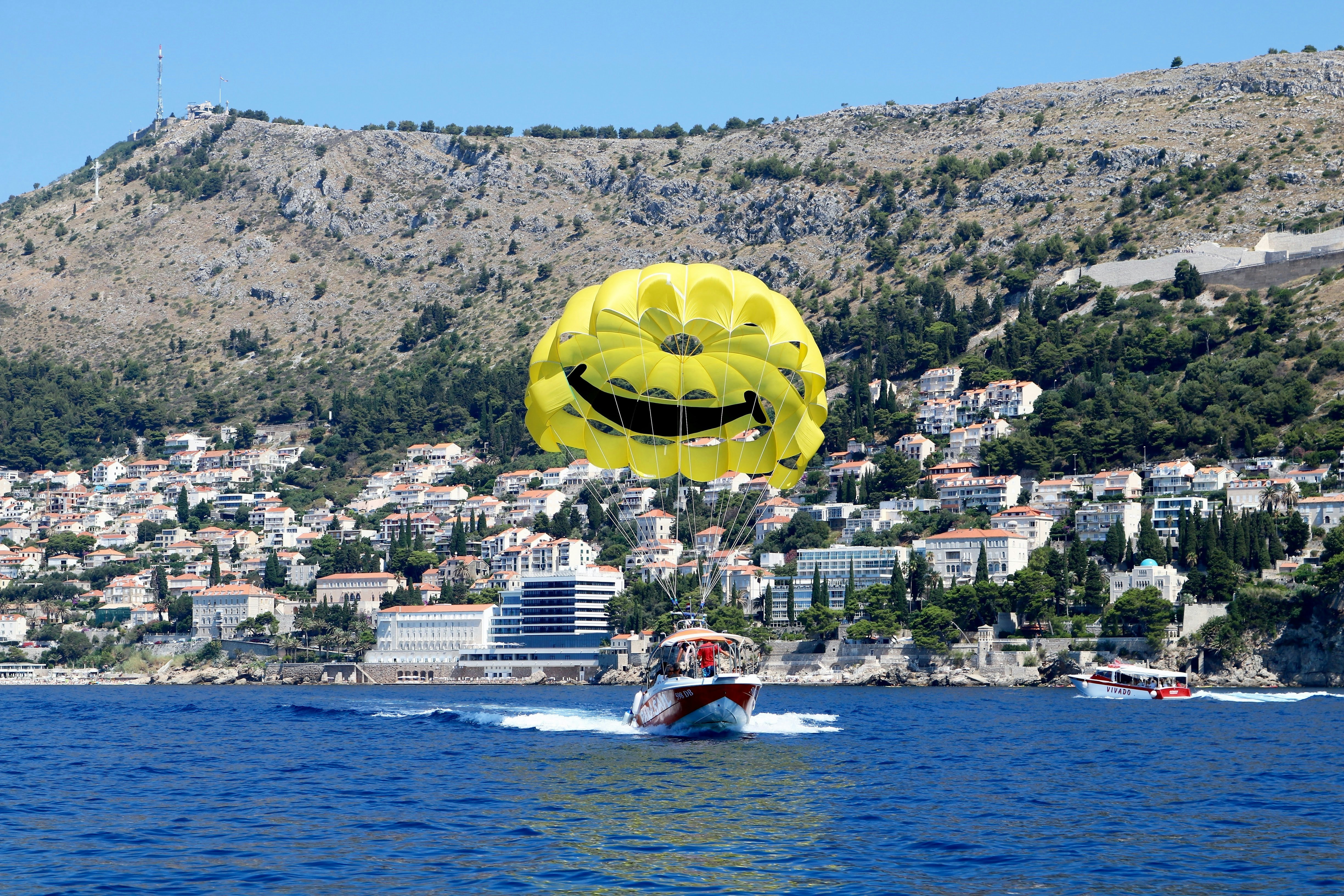 Yellow and red hot air balloon over city buildings during daytime photo ...