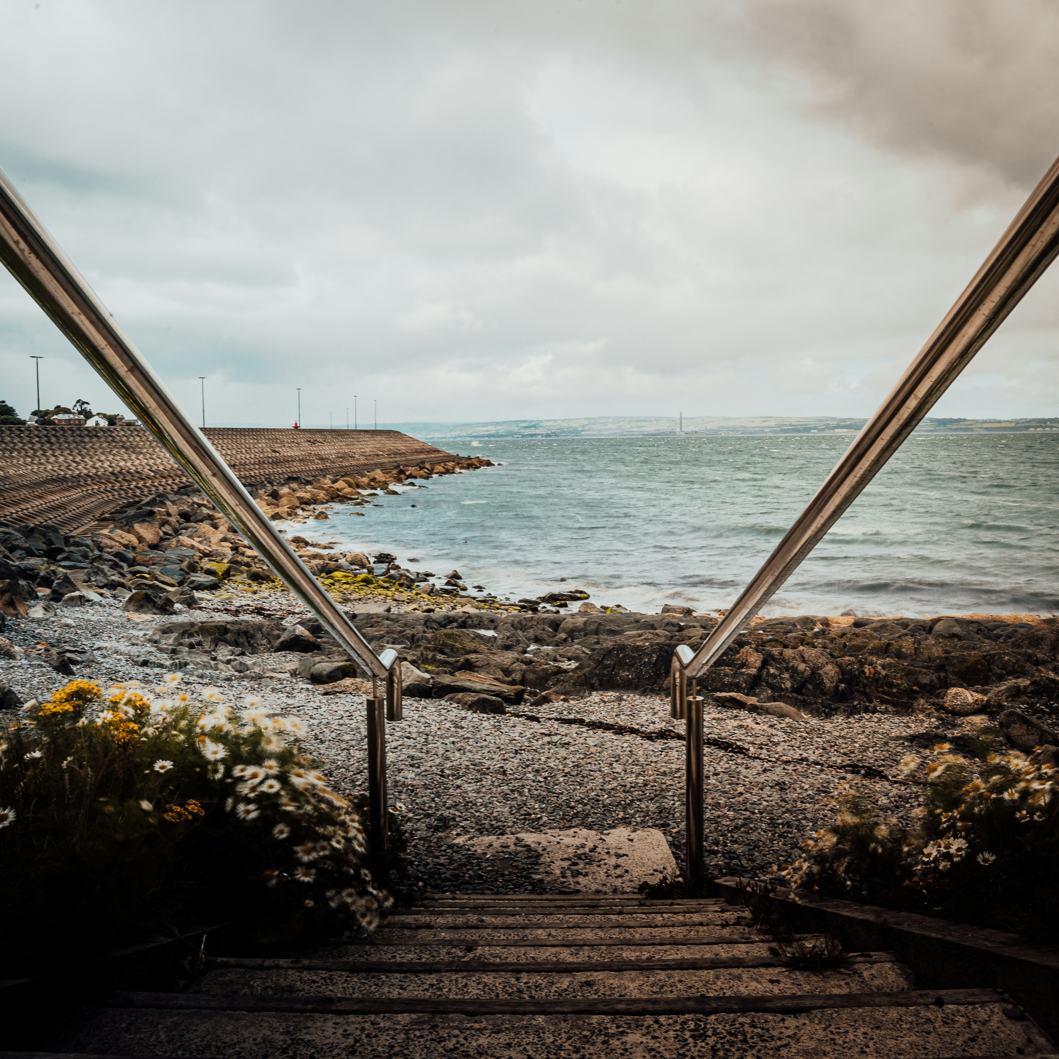 Rusted Rails to the Sea: A Staircase Framing the Atlantic Approach