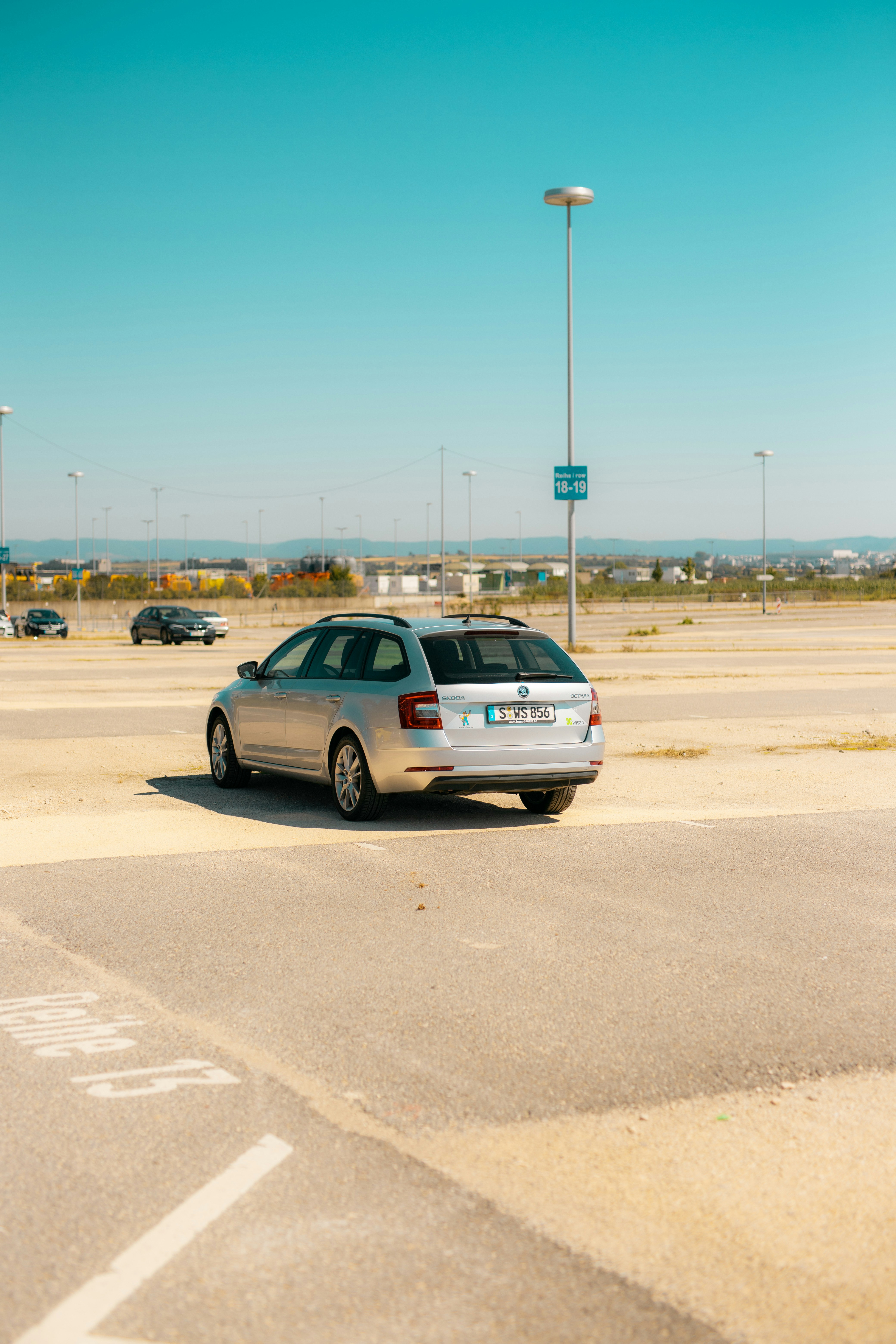 Solitary Silver Wagon in a Cerulean Desert Parking Lot