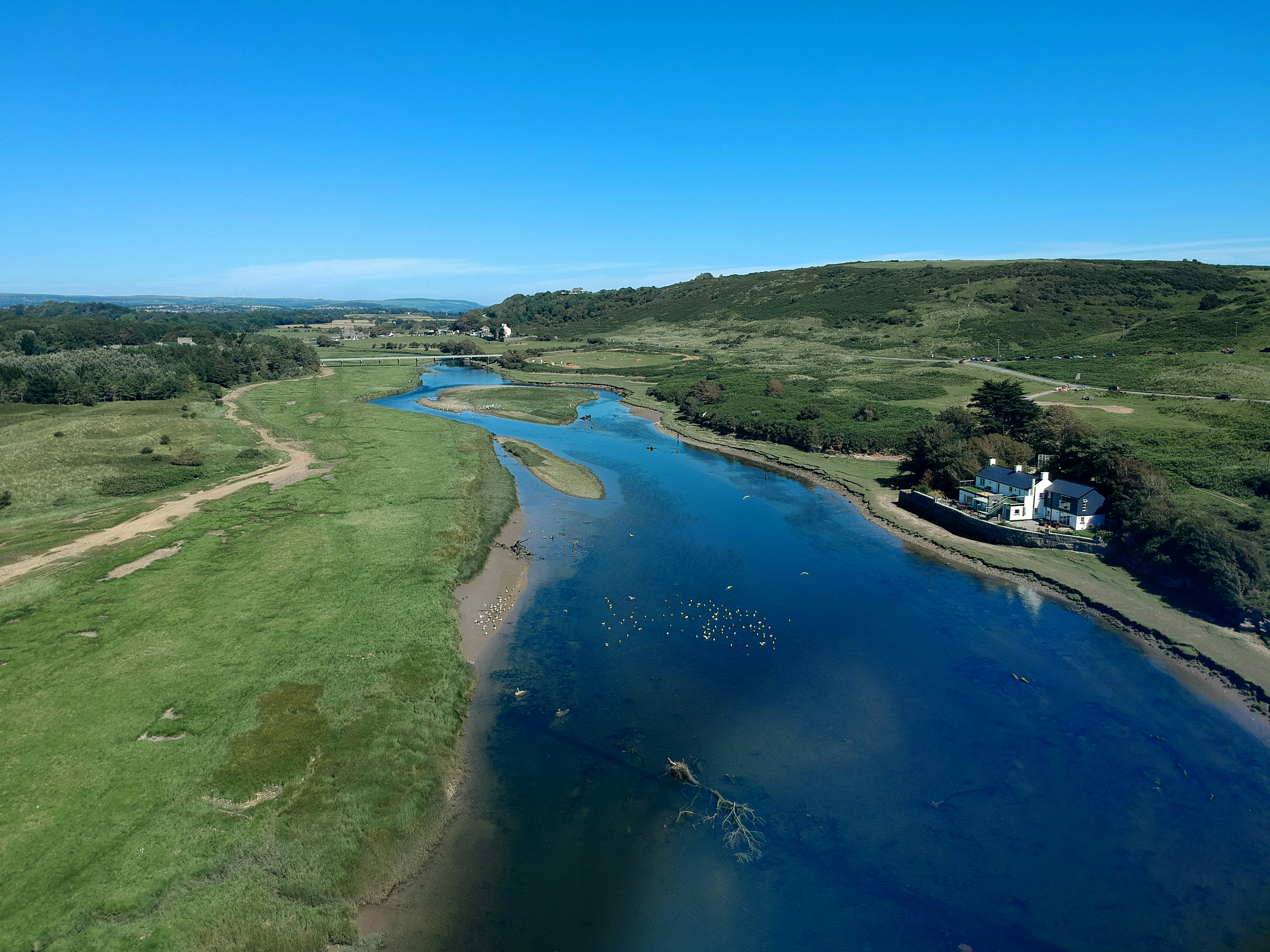 Aerial Drift: River Meanders Through Green Valley
