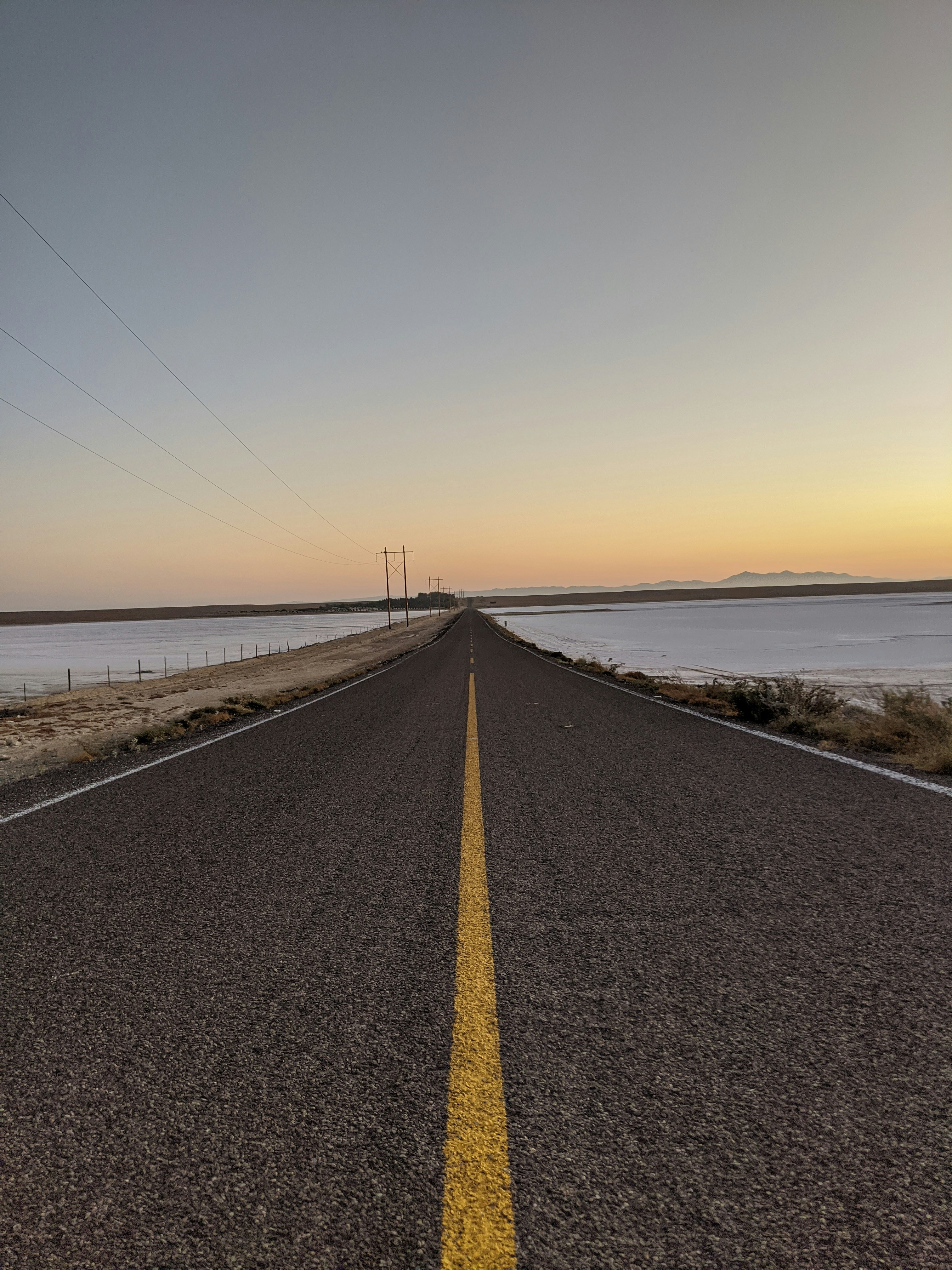 The Vanishing Highway: Sunset on a Lone Salt-Flat Road