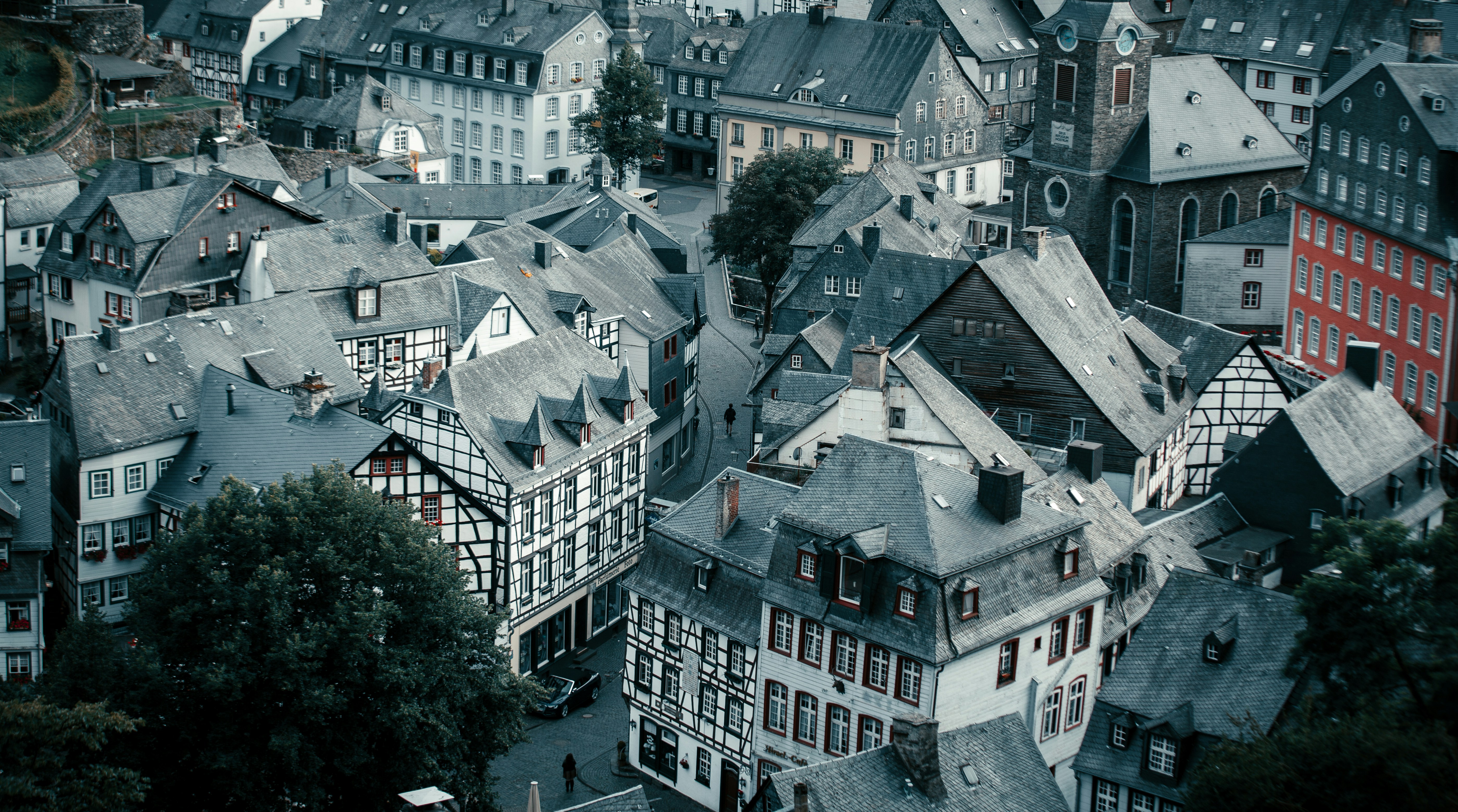 Aerial view of historic buildings with slate rooftops in Monschau, Germany.