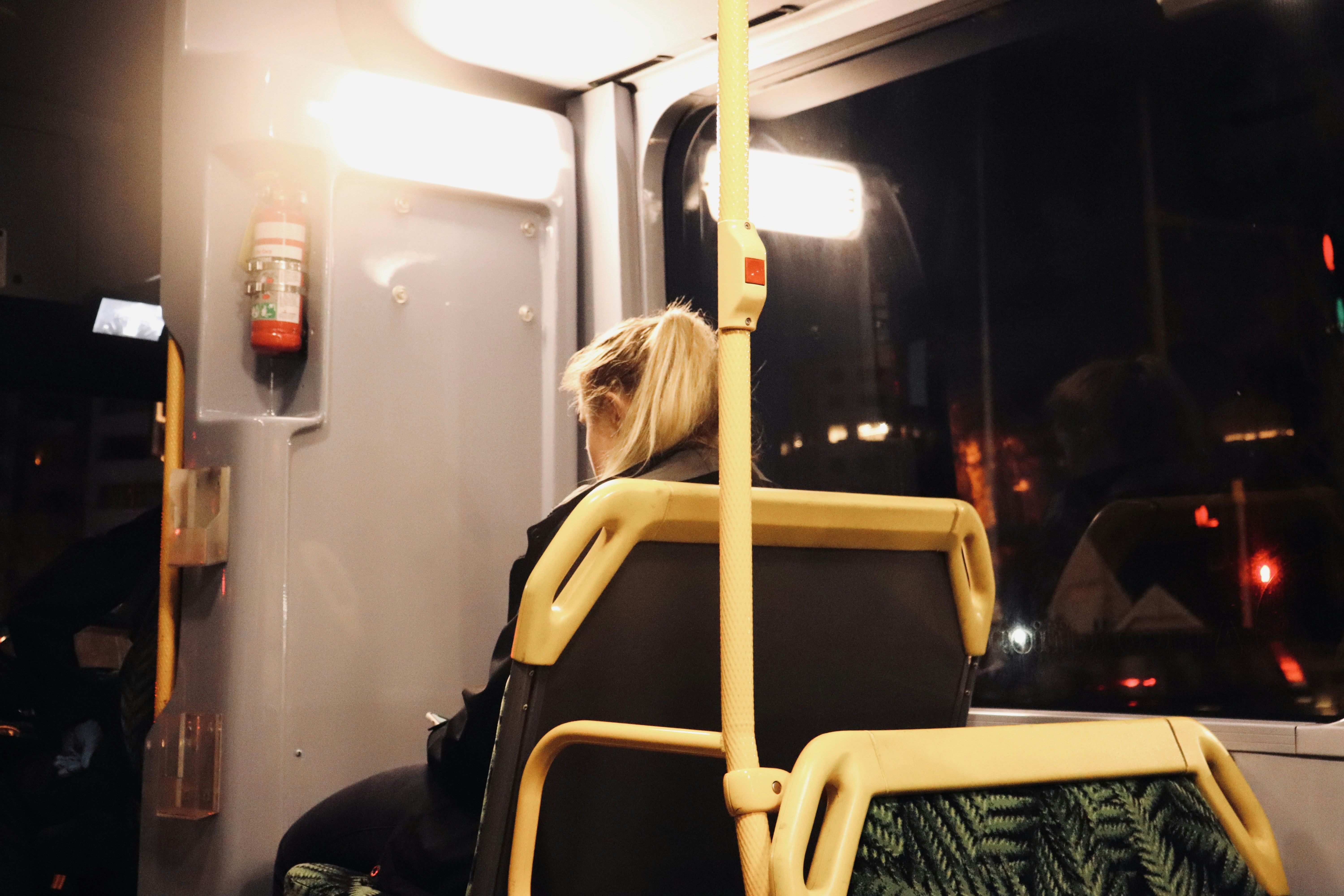 Backlit Quiet: A Night Bus Portrait in Warm Yellow Light
