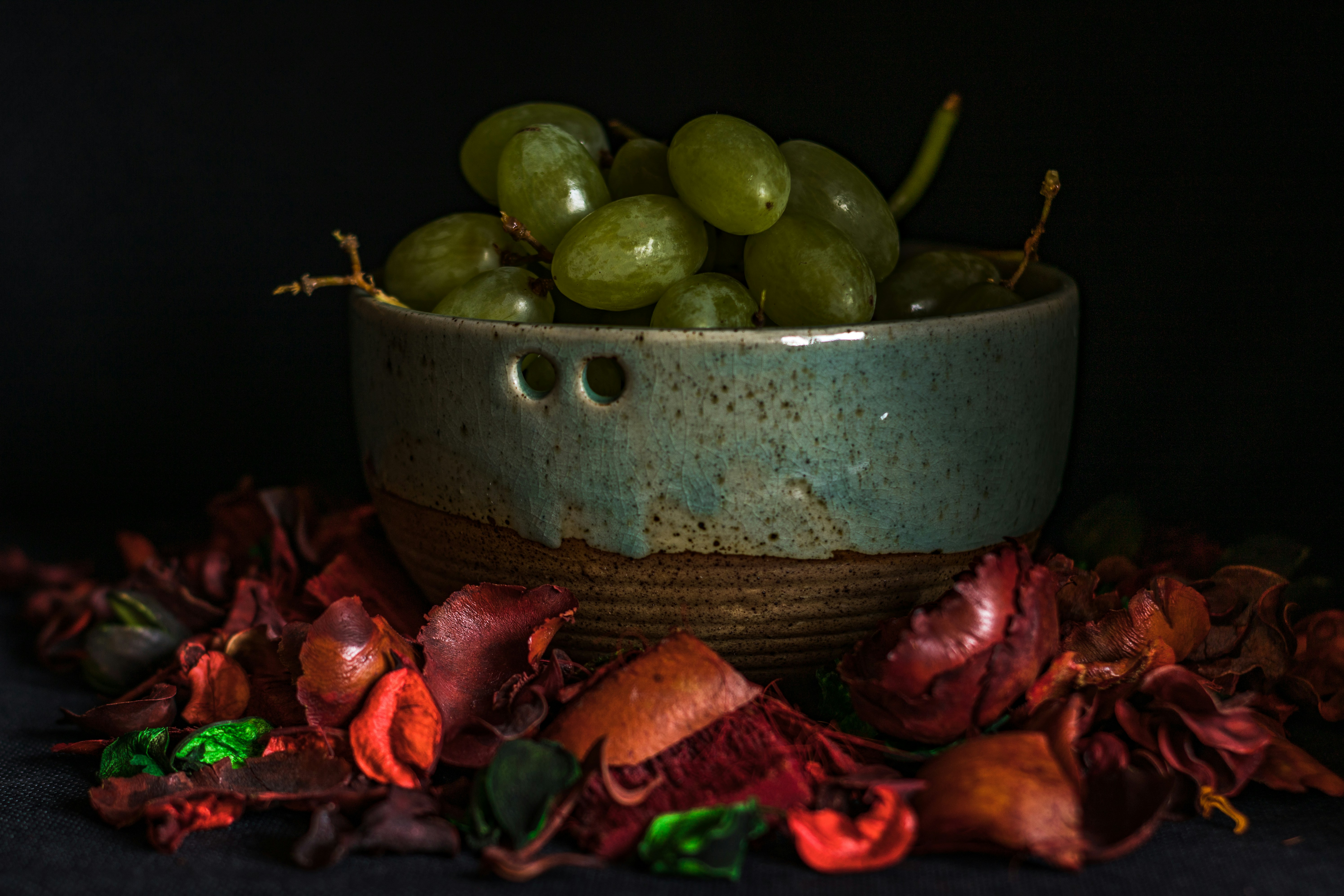 Teal-glazed Bowl Cradling Emerald Grapes Beneath Velvet Shadows