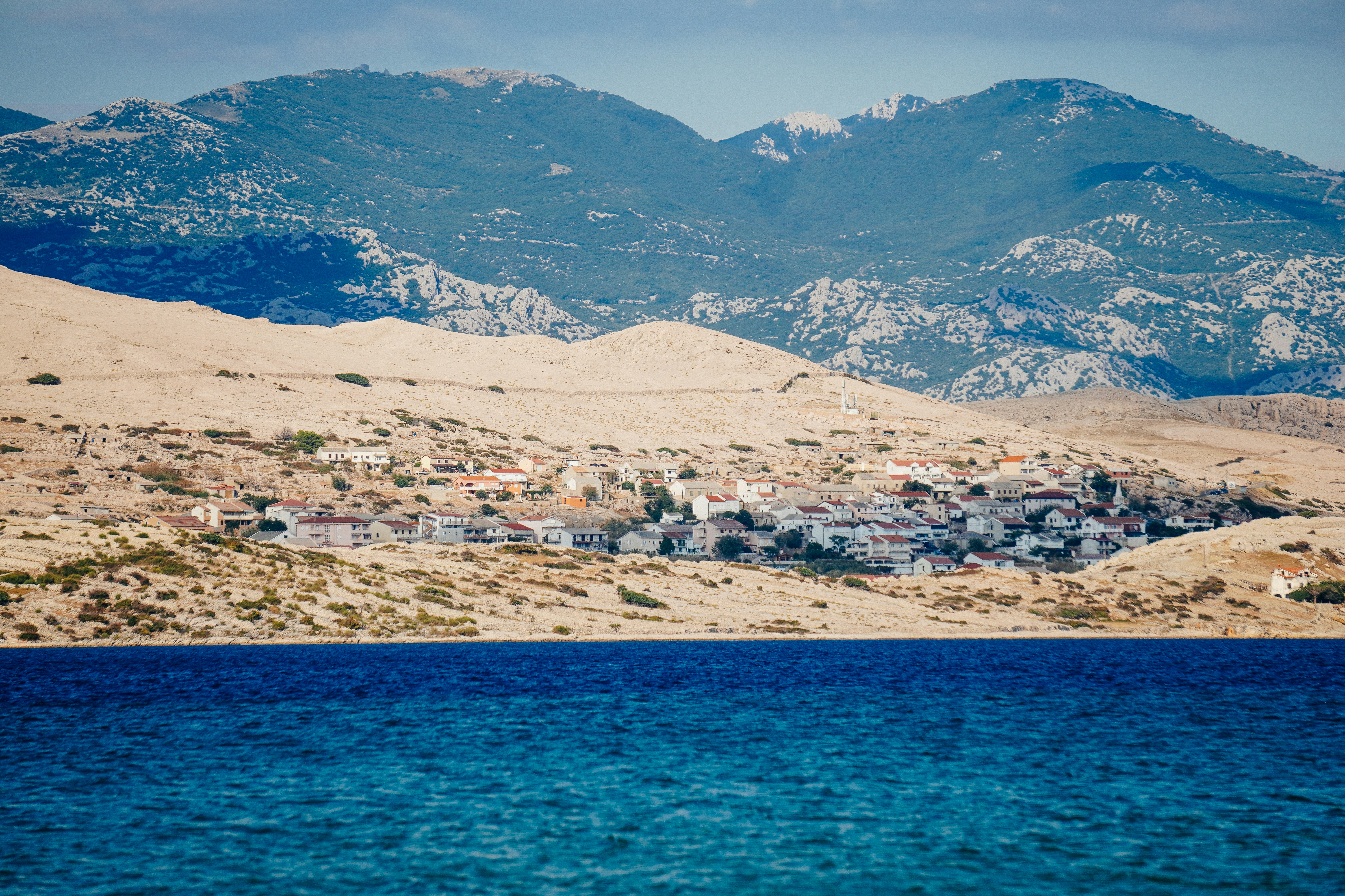 Coastal Town Between Dunes and Distant Peaks