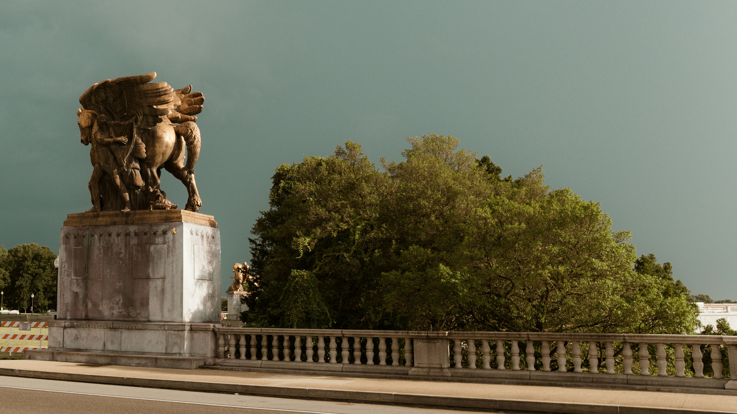 brown statue near green trees during daytime