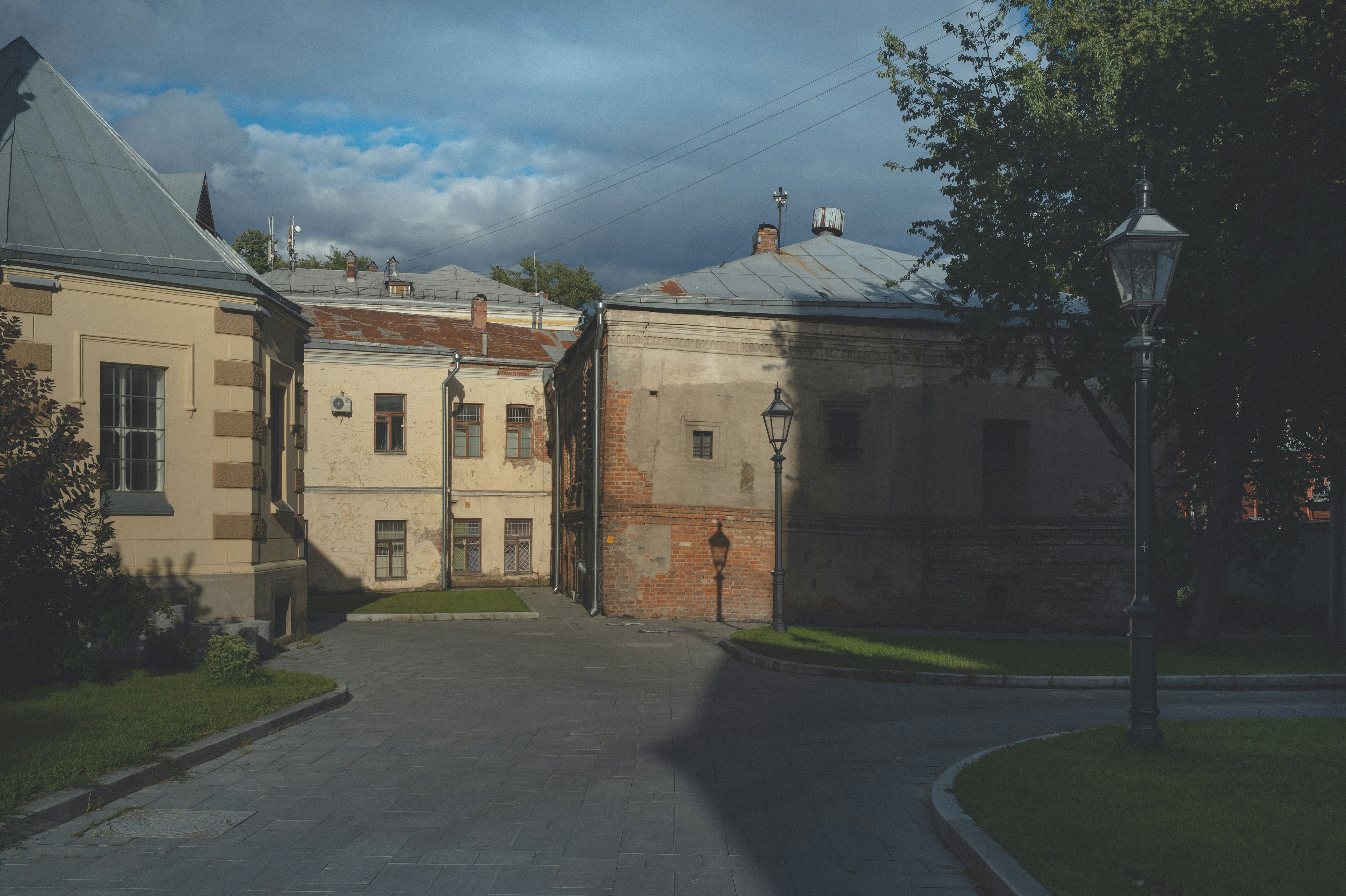 Arcade of Stone: A Quiet Courtyard Path Between Weathered Walls