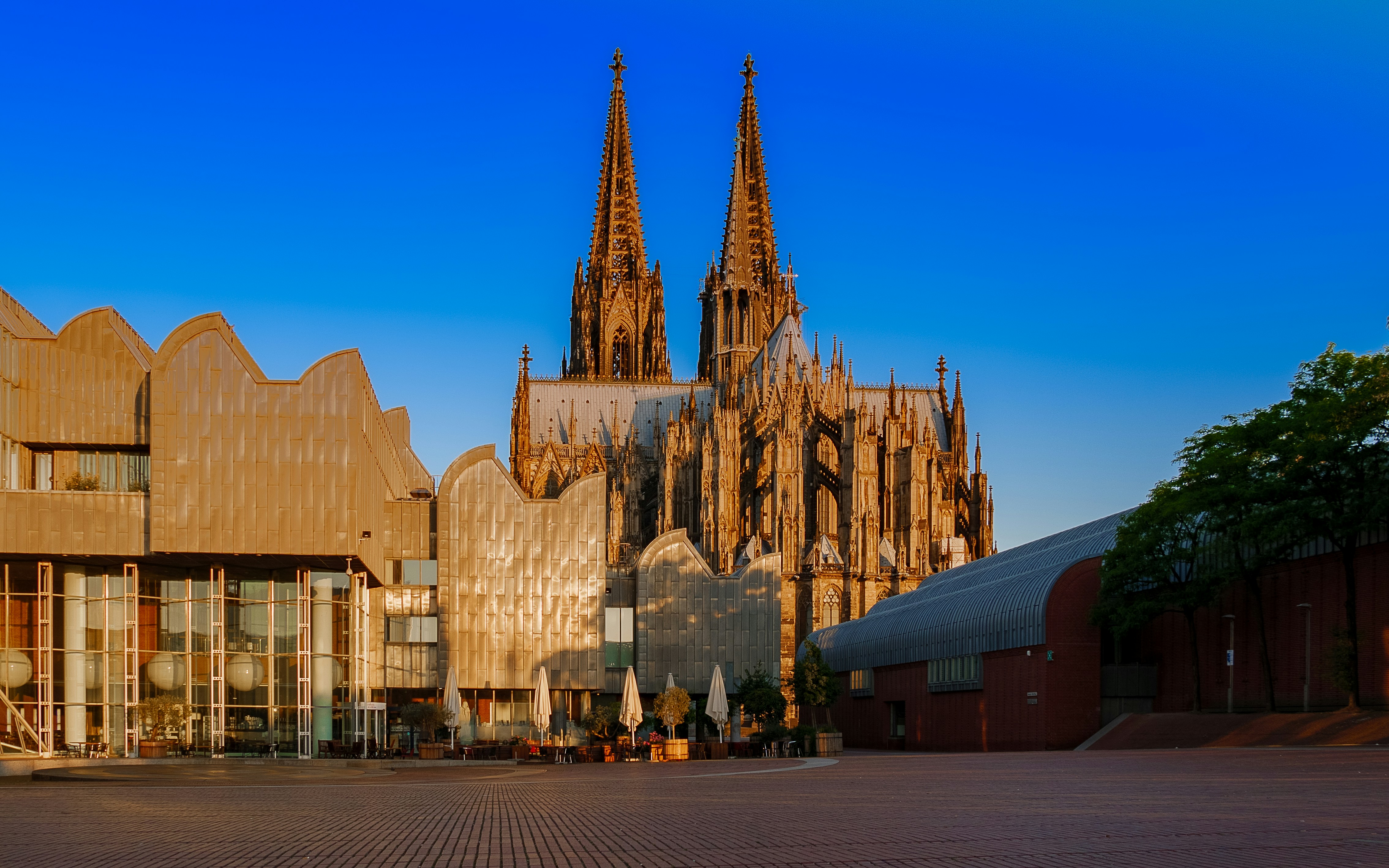 Sunset at the Philharmony with view to the dome from behind | people walking near brown concrete building during daytime