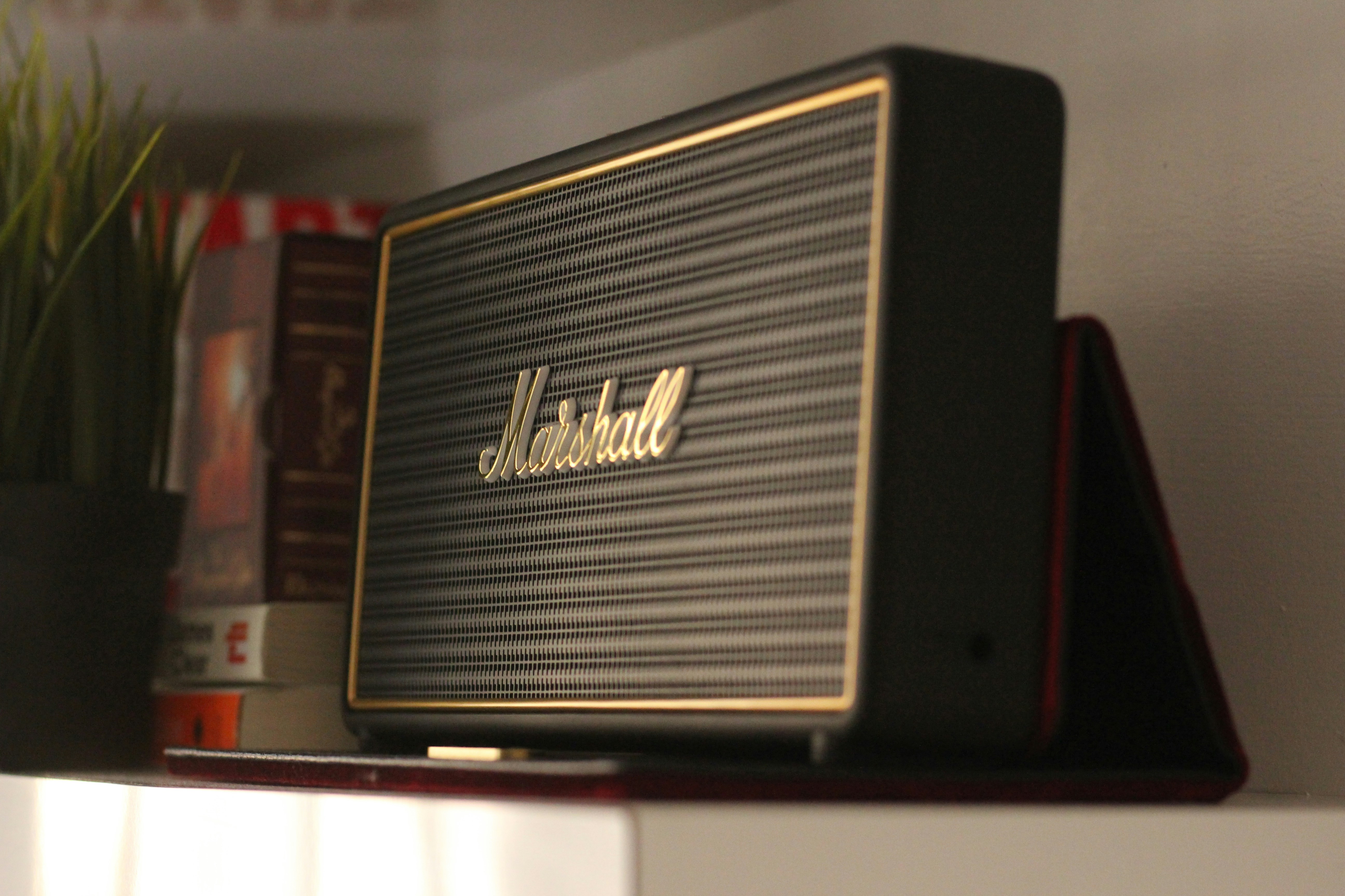 a black and gold radio sitting on top of a shelf