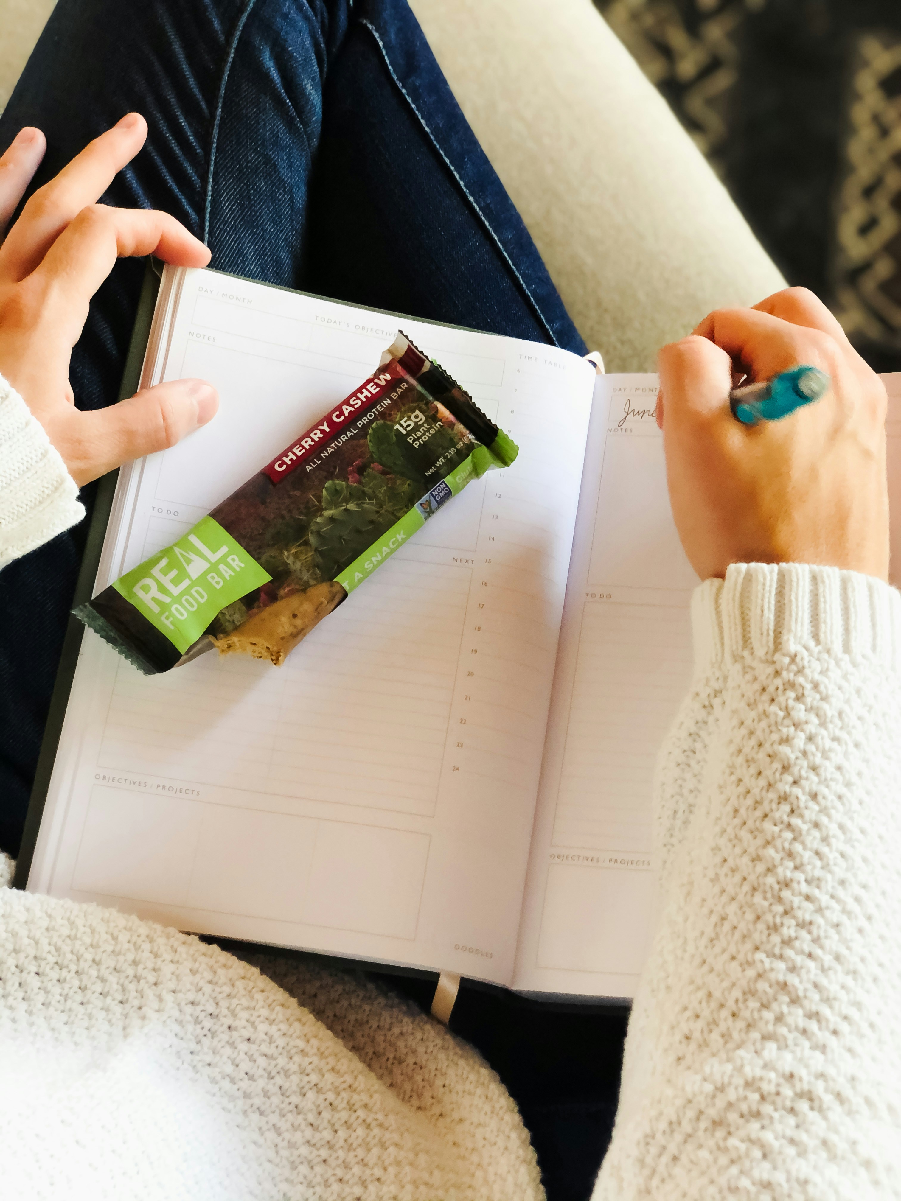 Cozy Desk Moment: A Green-Packaged Snack Diagonally Spreads Across an Open Journal