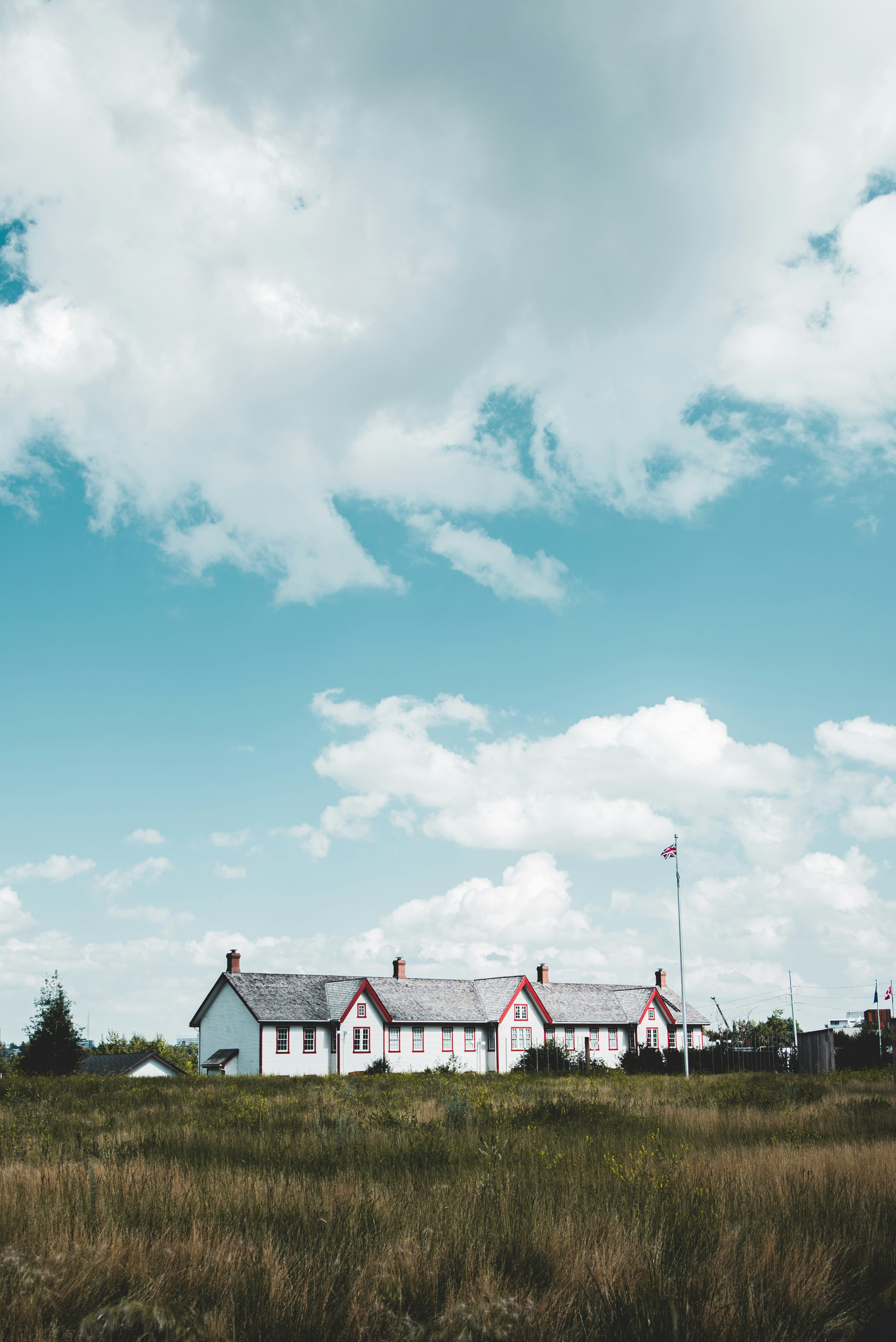 white and red house under blue sky during daytime