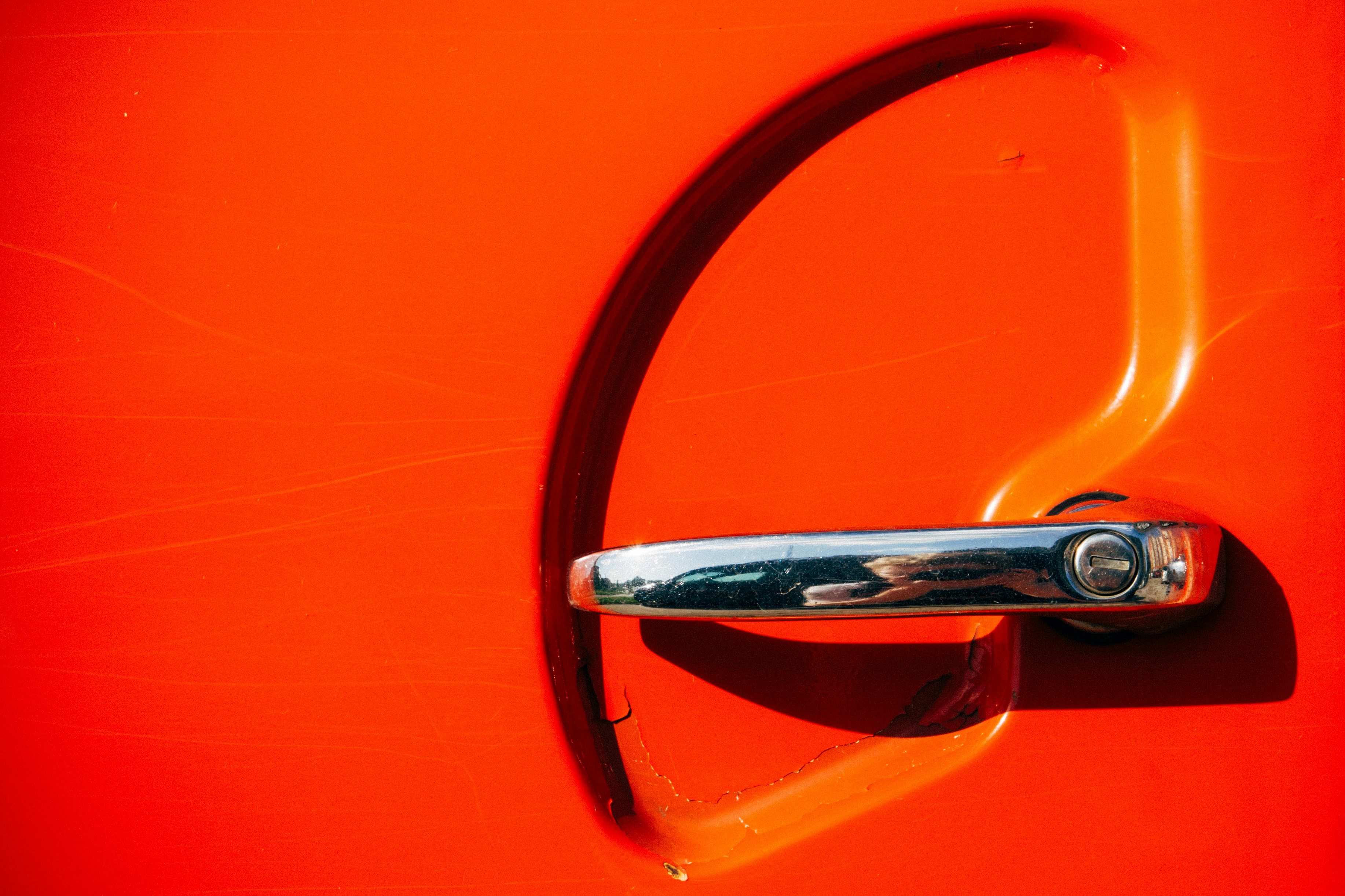 Chrome Latch on a Fiery Orange Panel
