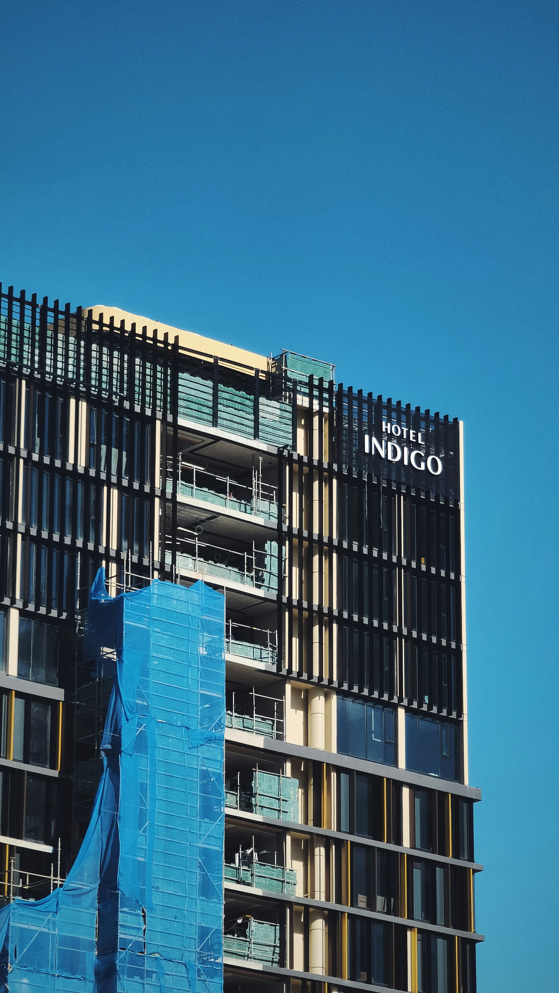 Indigo Hotel Facade: Steel Grids Meet Blue Sky