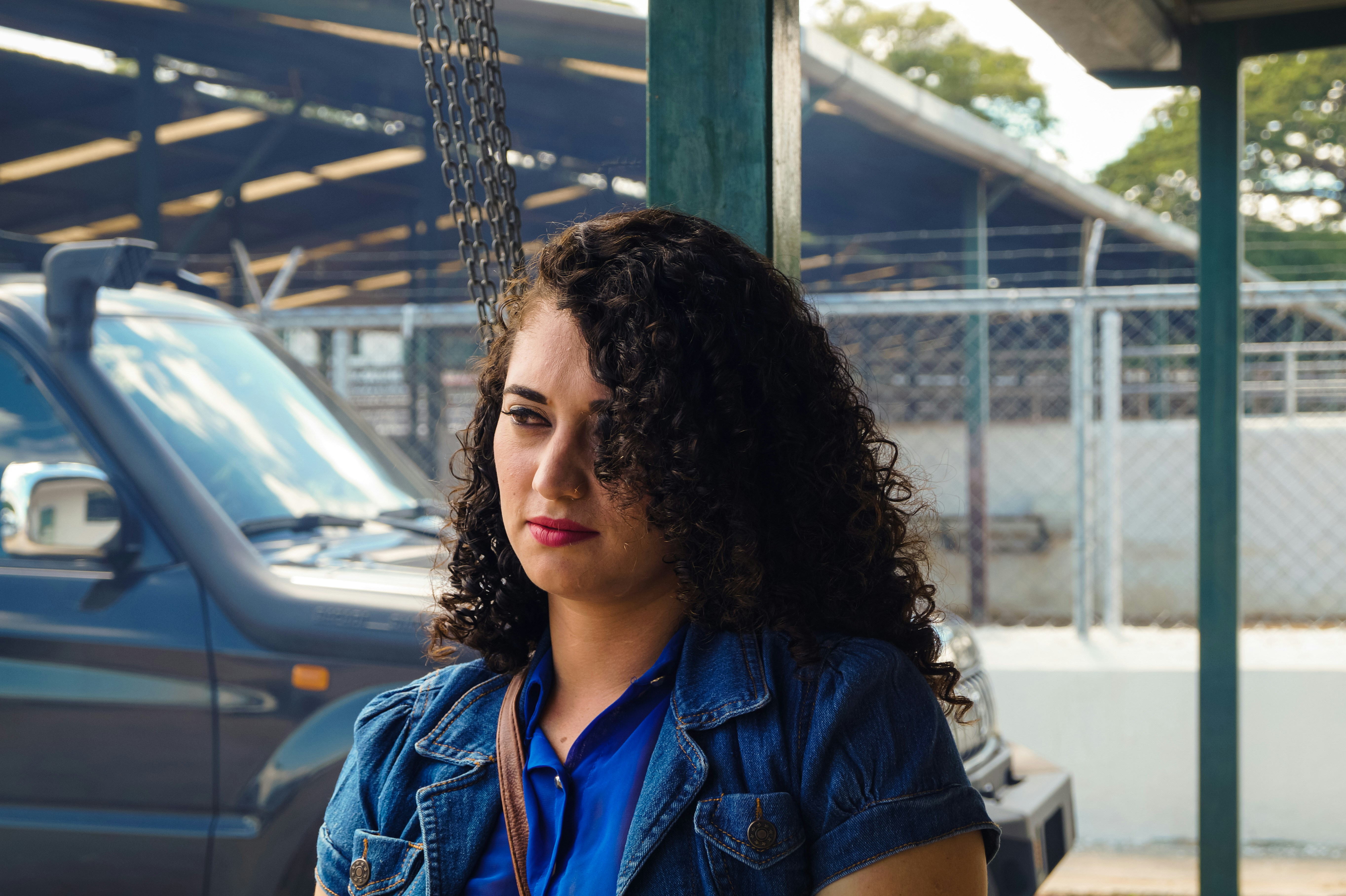 Platform Portrait: Denim Confidence Beneath an Industrial Canopy