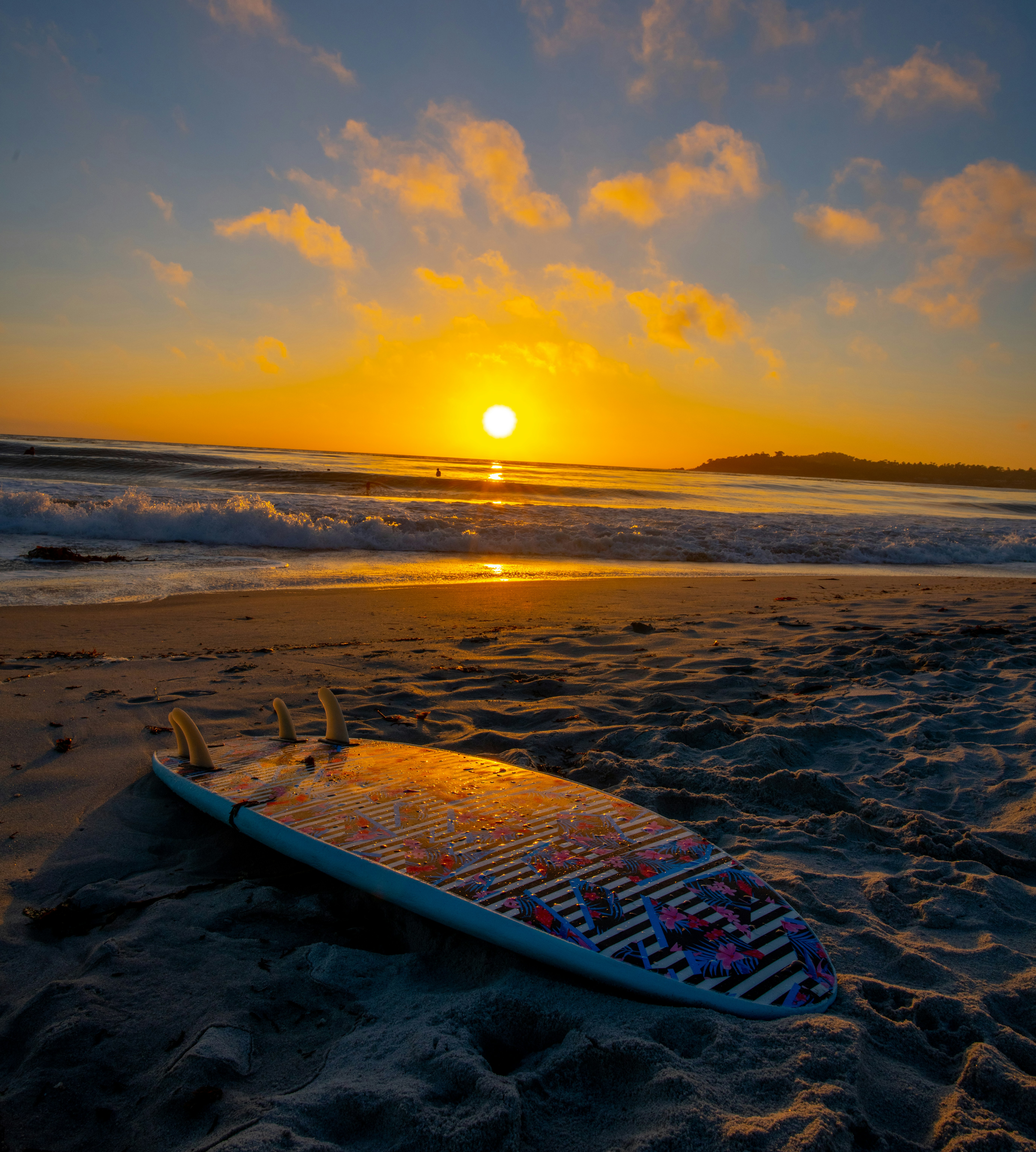Gold Hour Wake: Surfboard Resting on a Quiet Sunset Shore