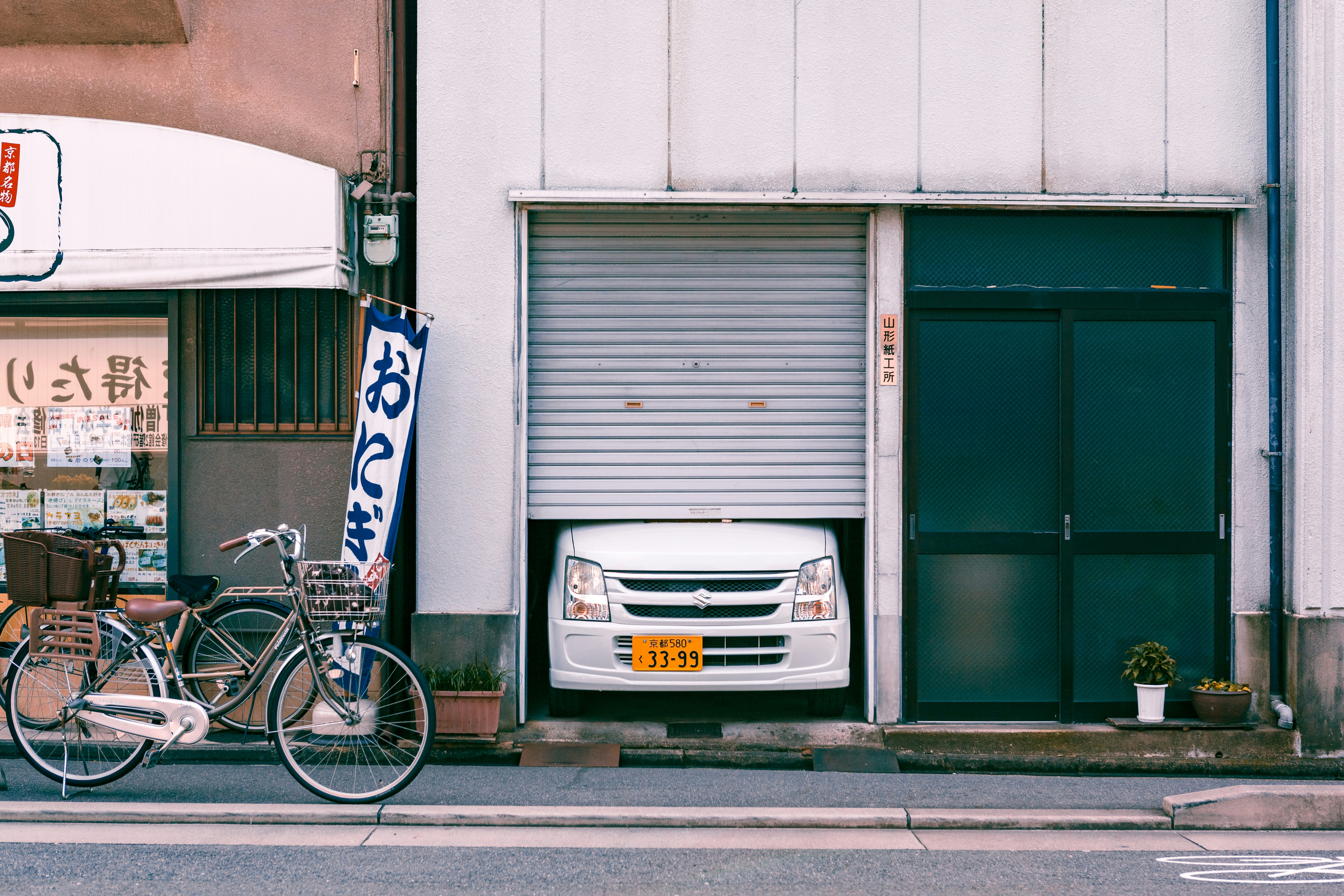 Garage Door, Bicycle, and Taxi in a Quiet Street Scene