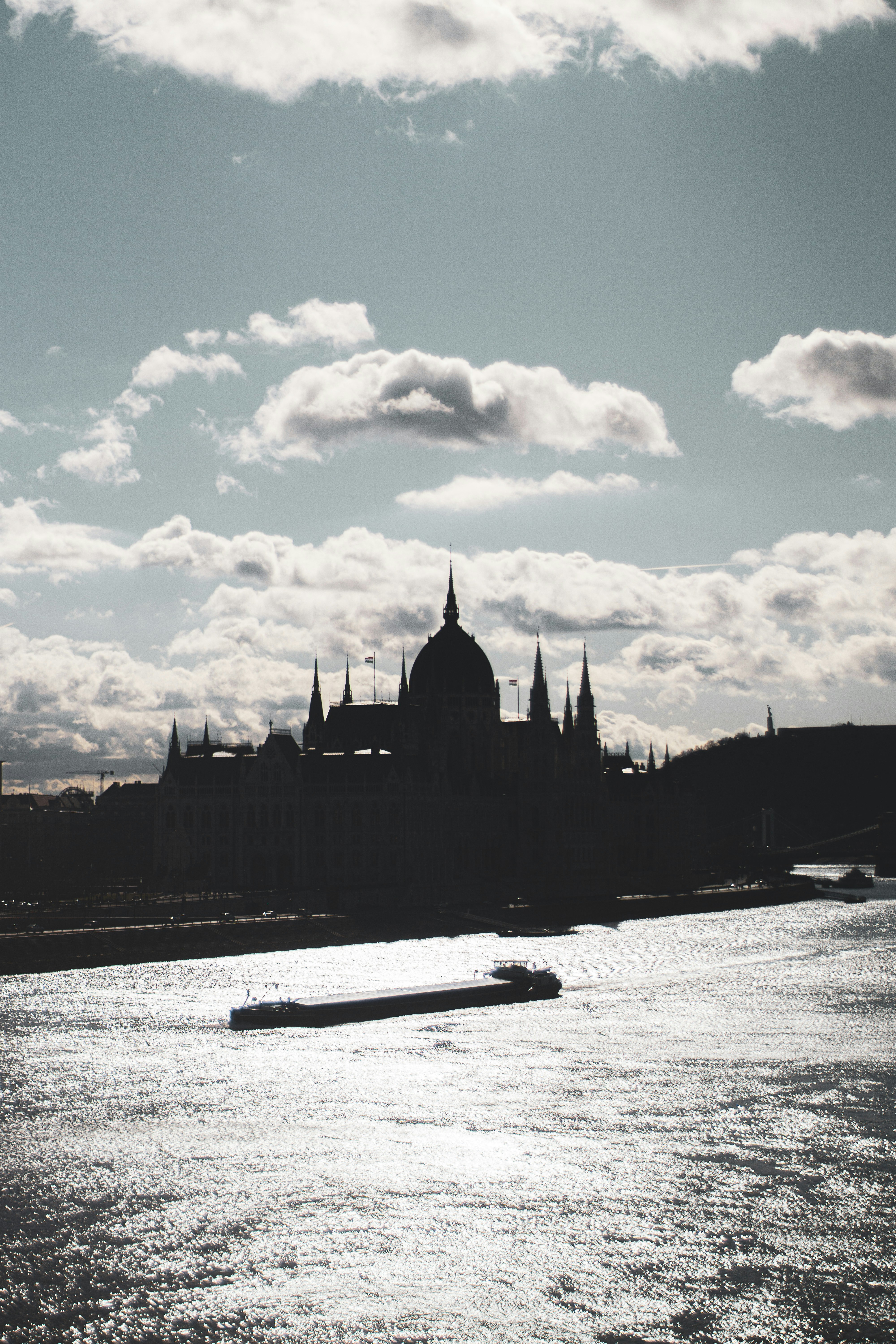 Silhouette Over the River: A City Skyline at Dusk