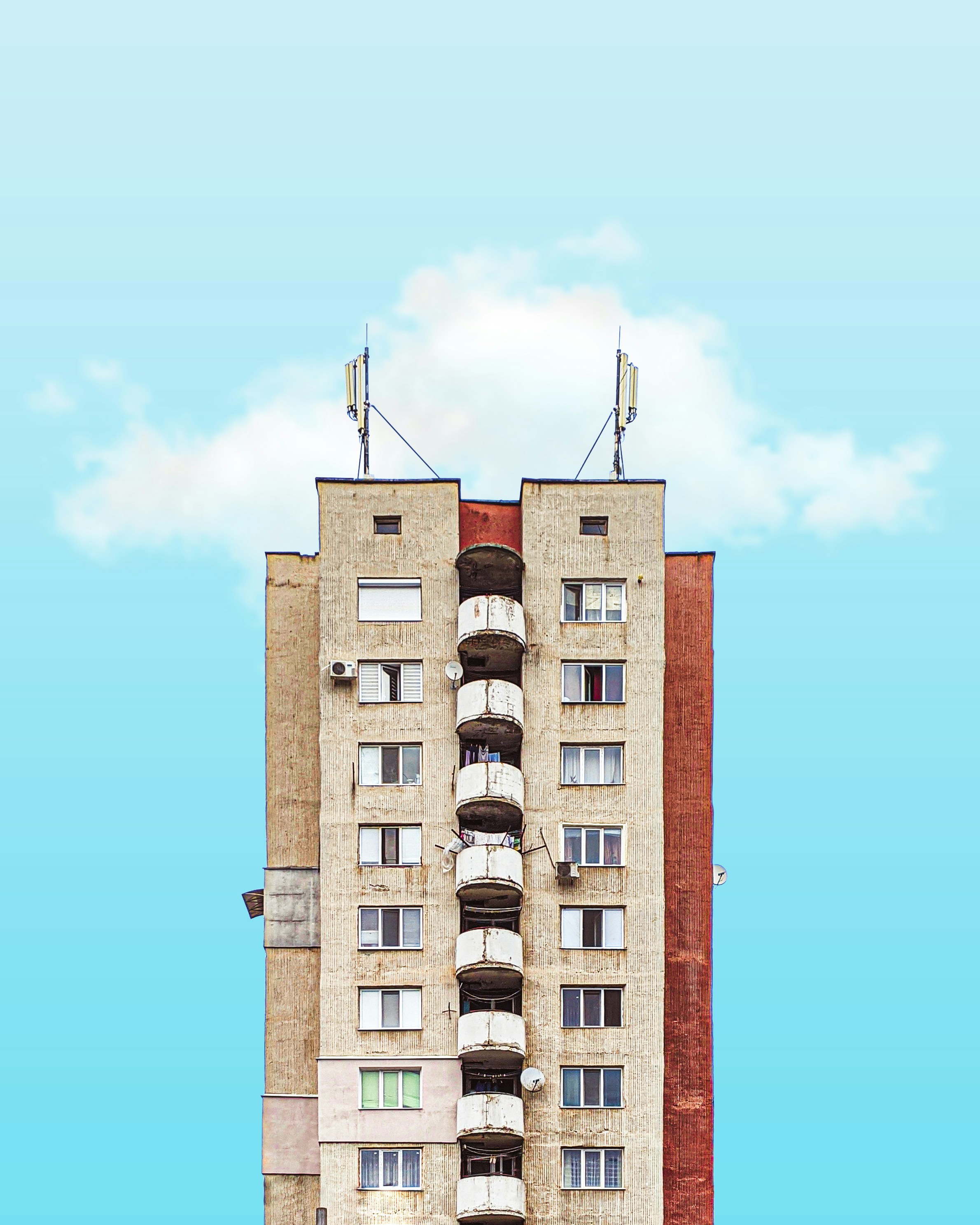Balconied Tower Rising Against a Clear Blue Sky