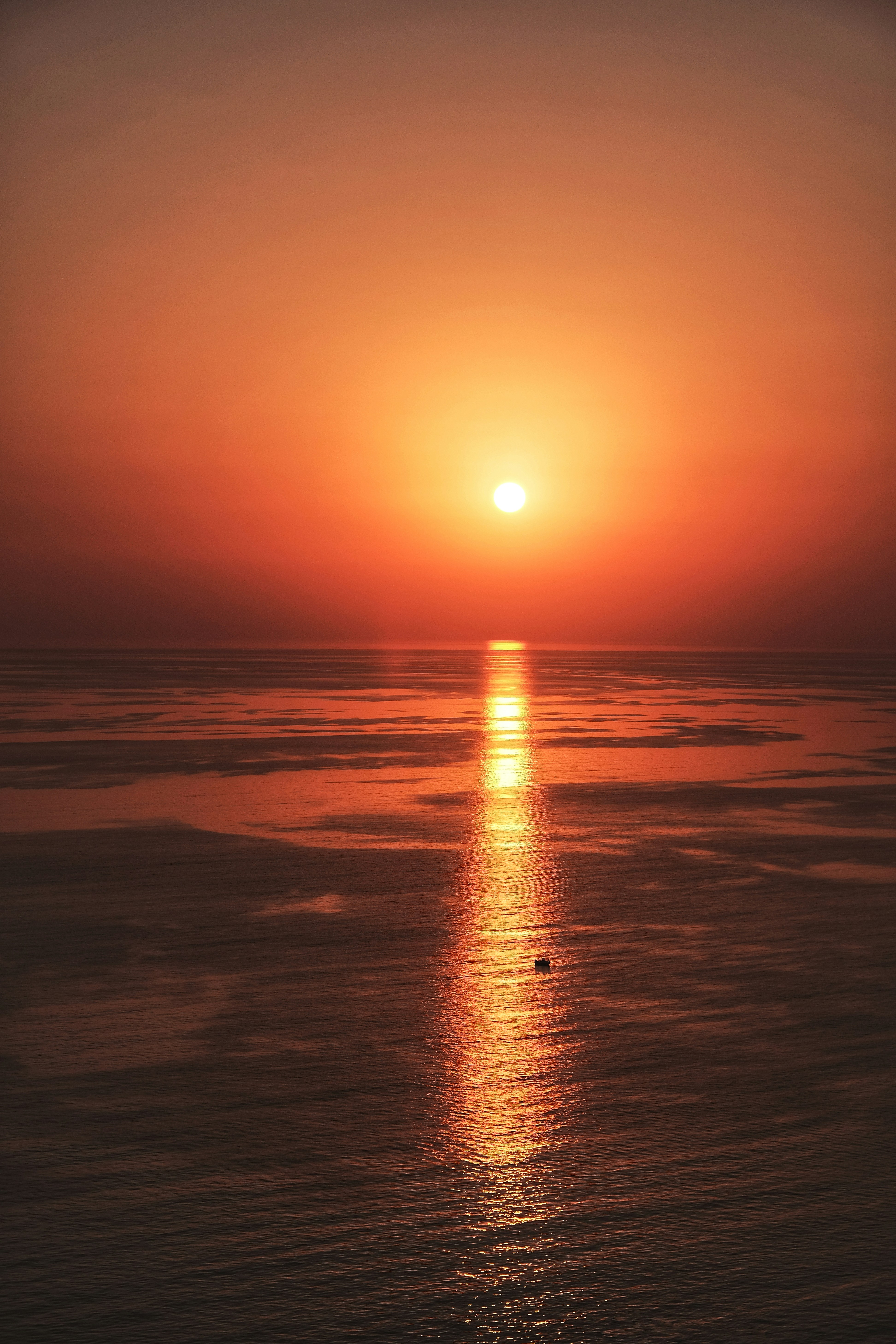 Luminous Horizon: Sunset Path over a Glassy Sea