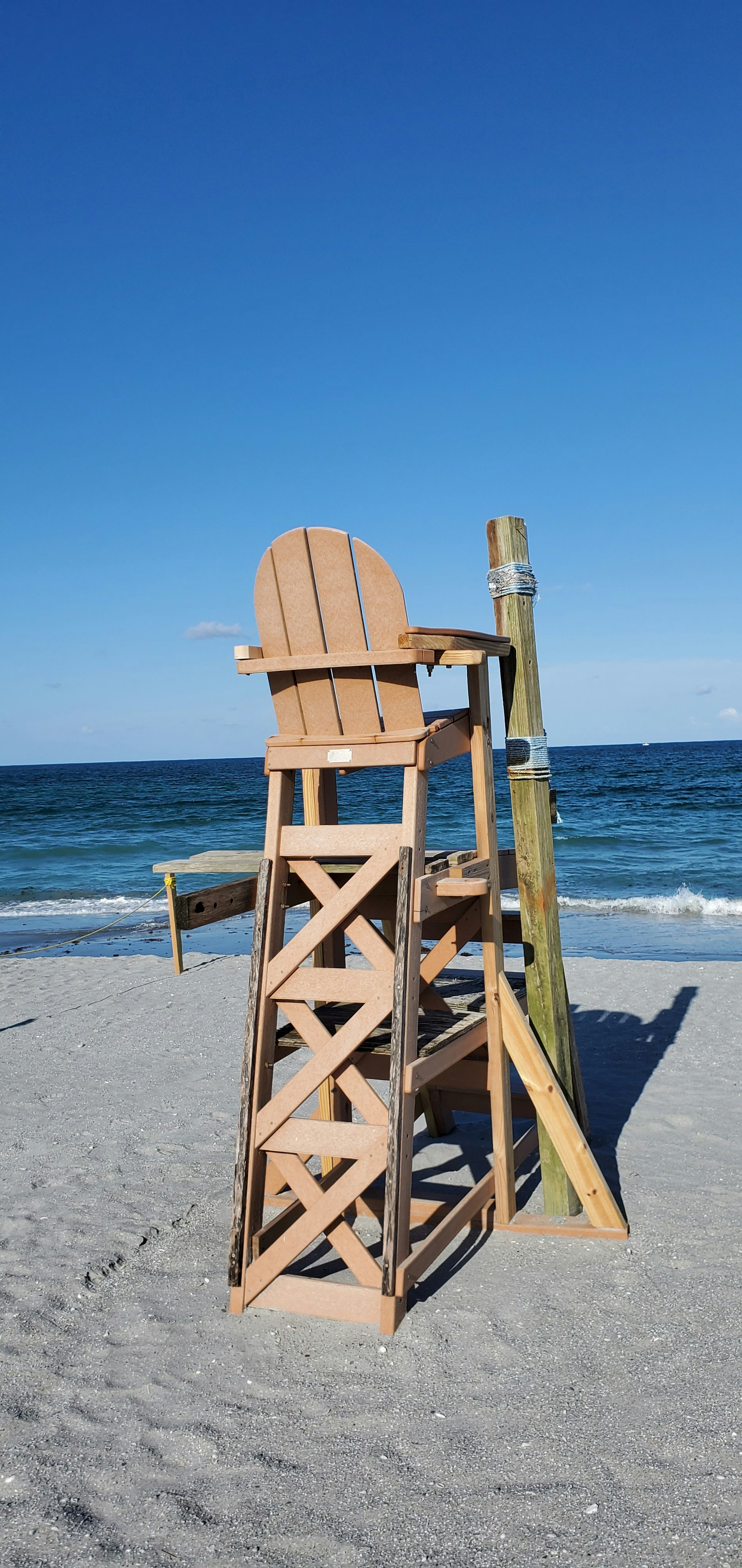 Weathered Lifeguard Chair Watches Over a Quiet Blue Seascape