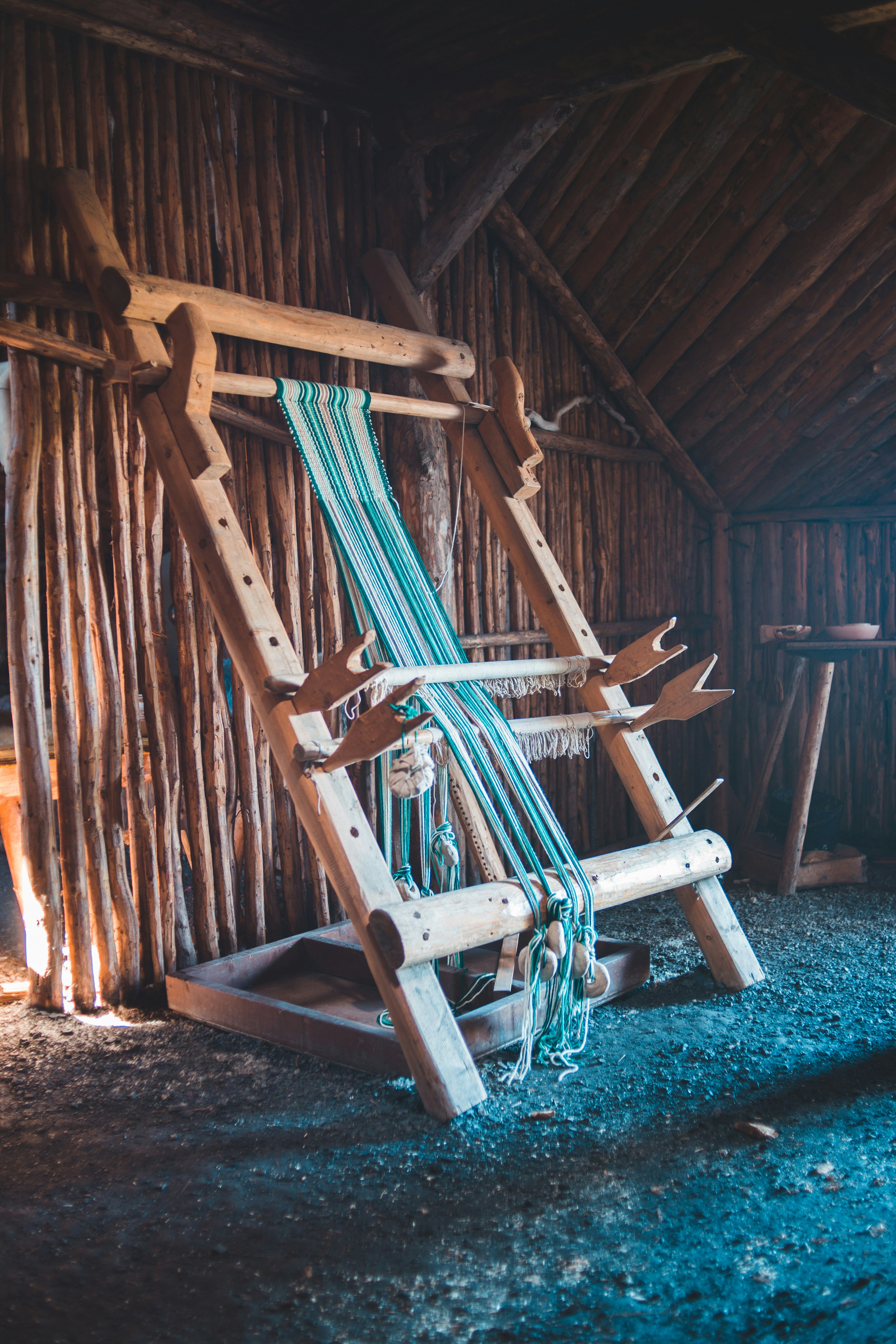 Threads of Light: A Loom Resting in an Old Wooden Workshop