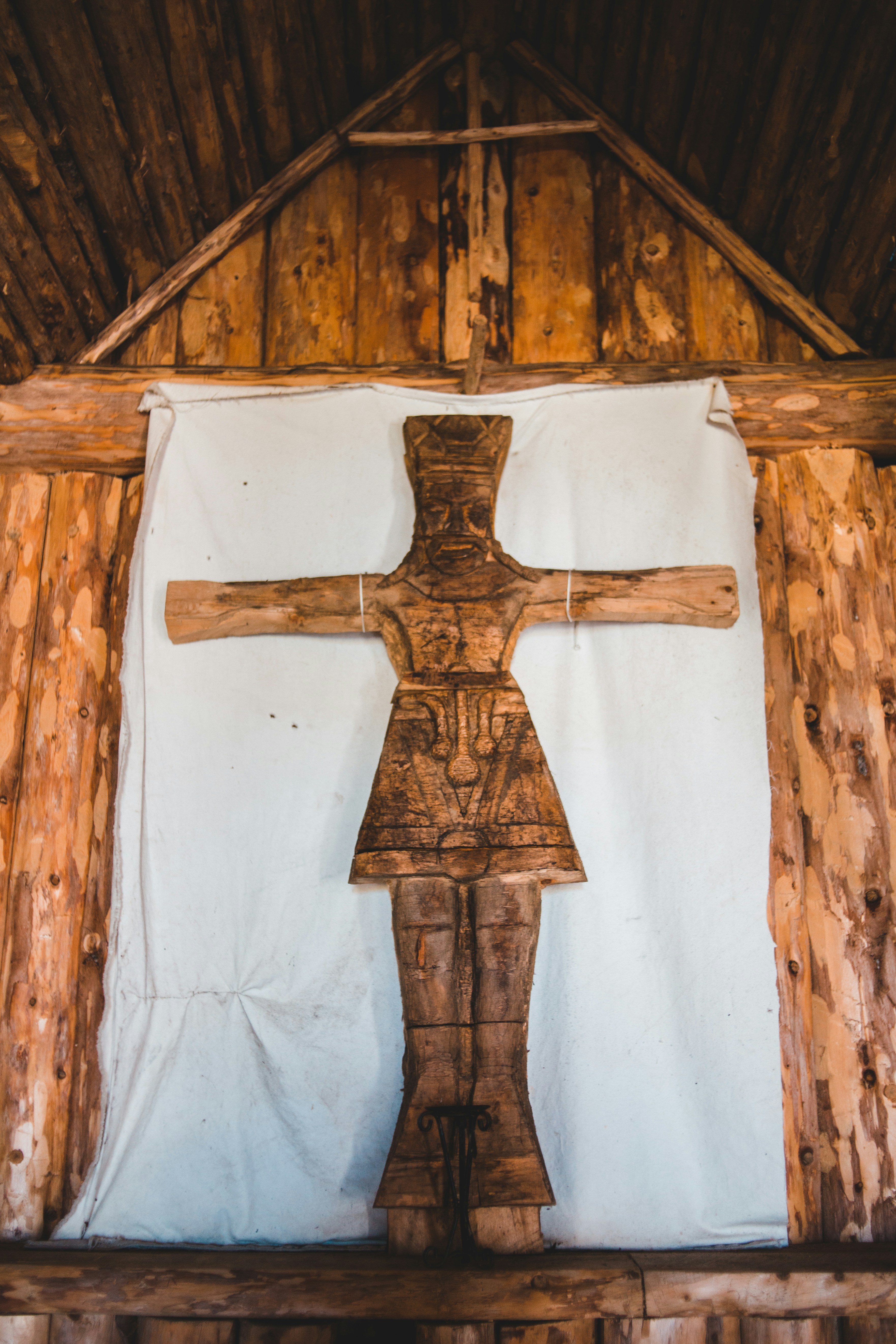 Wooden crucifix in a rustic chapel alcove