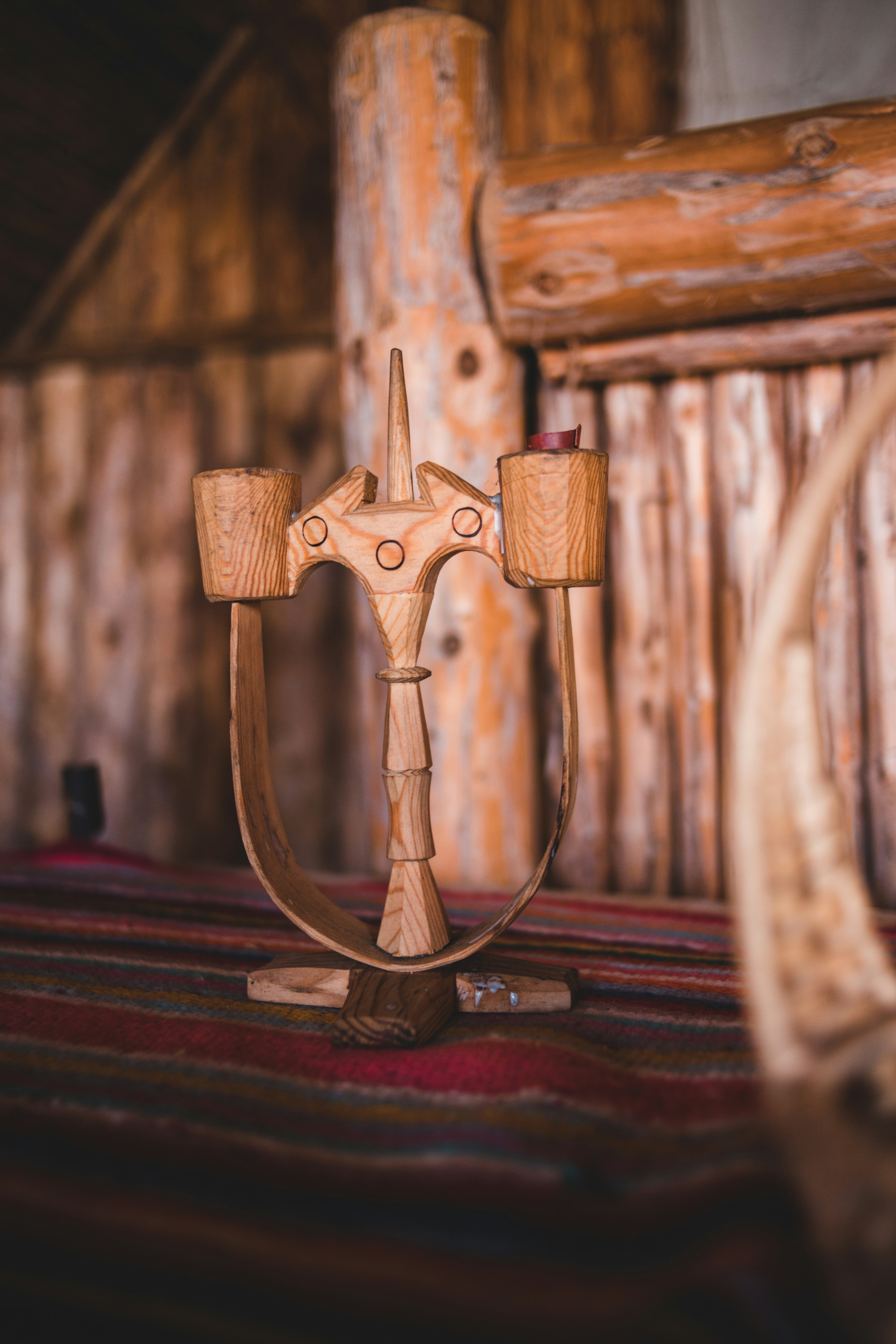 Nordic Candleholder on a Wool Rug in Rustic Cabin