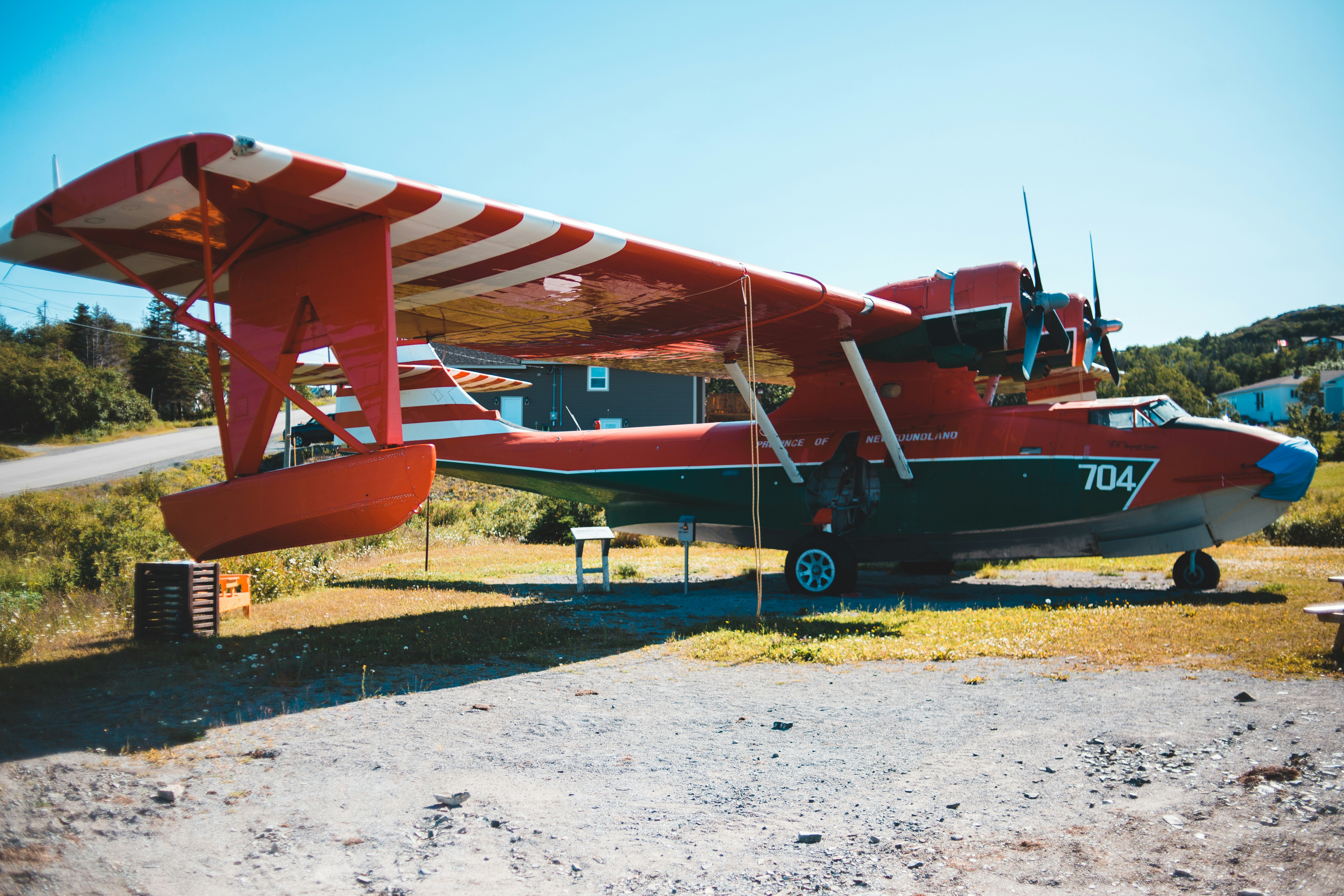 red and white airplane under blue sky during daytime