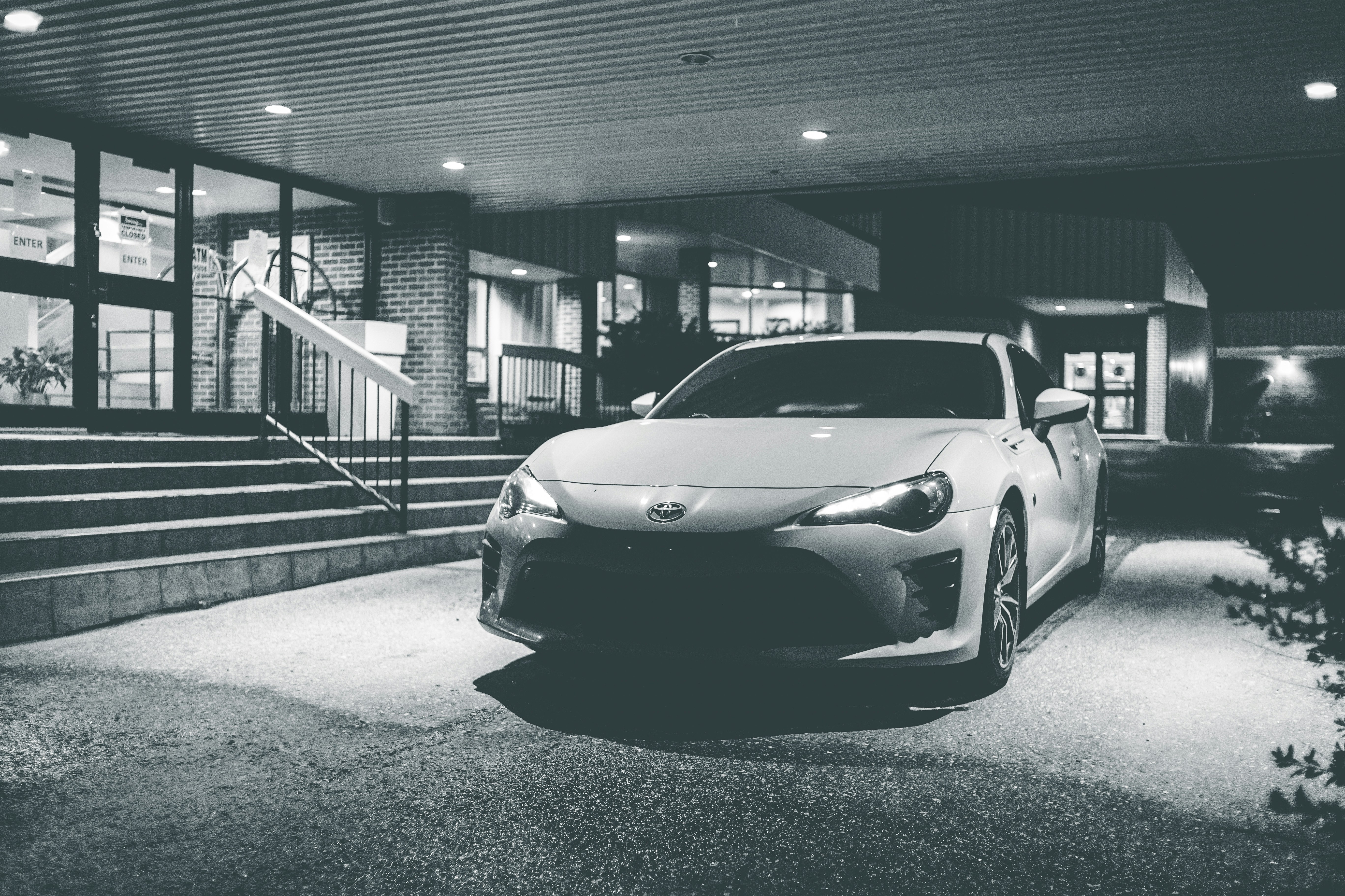 Grayscale photo of bmw coupe parked near building photo – Free Grey ...