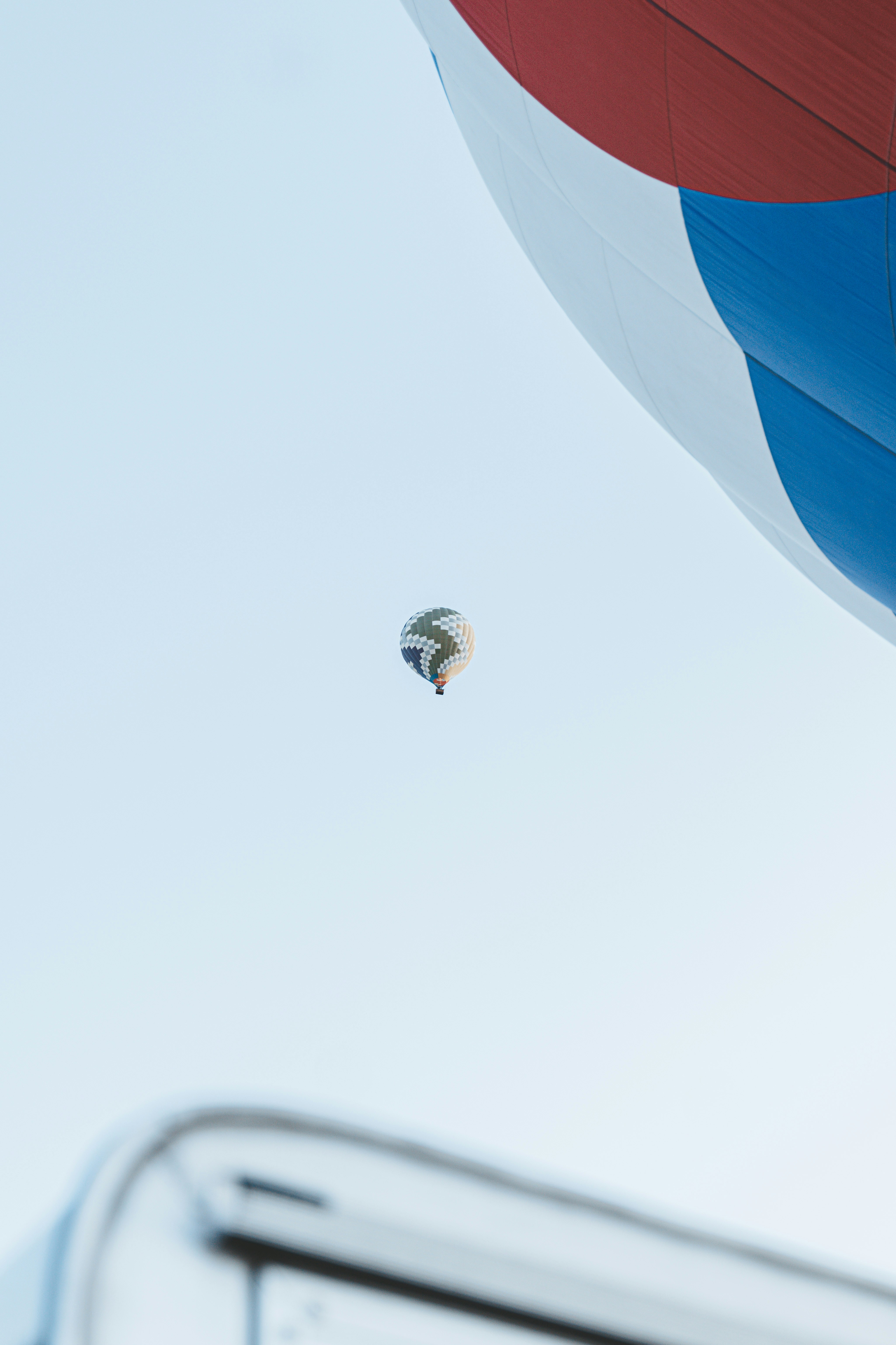 Skybound Distant: A Lone Hot Air Balloon in a Quiet Blue Sky